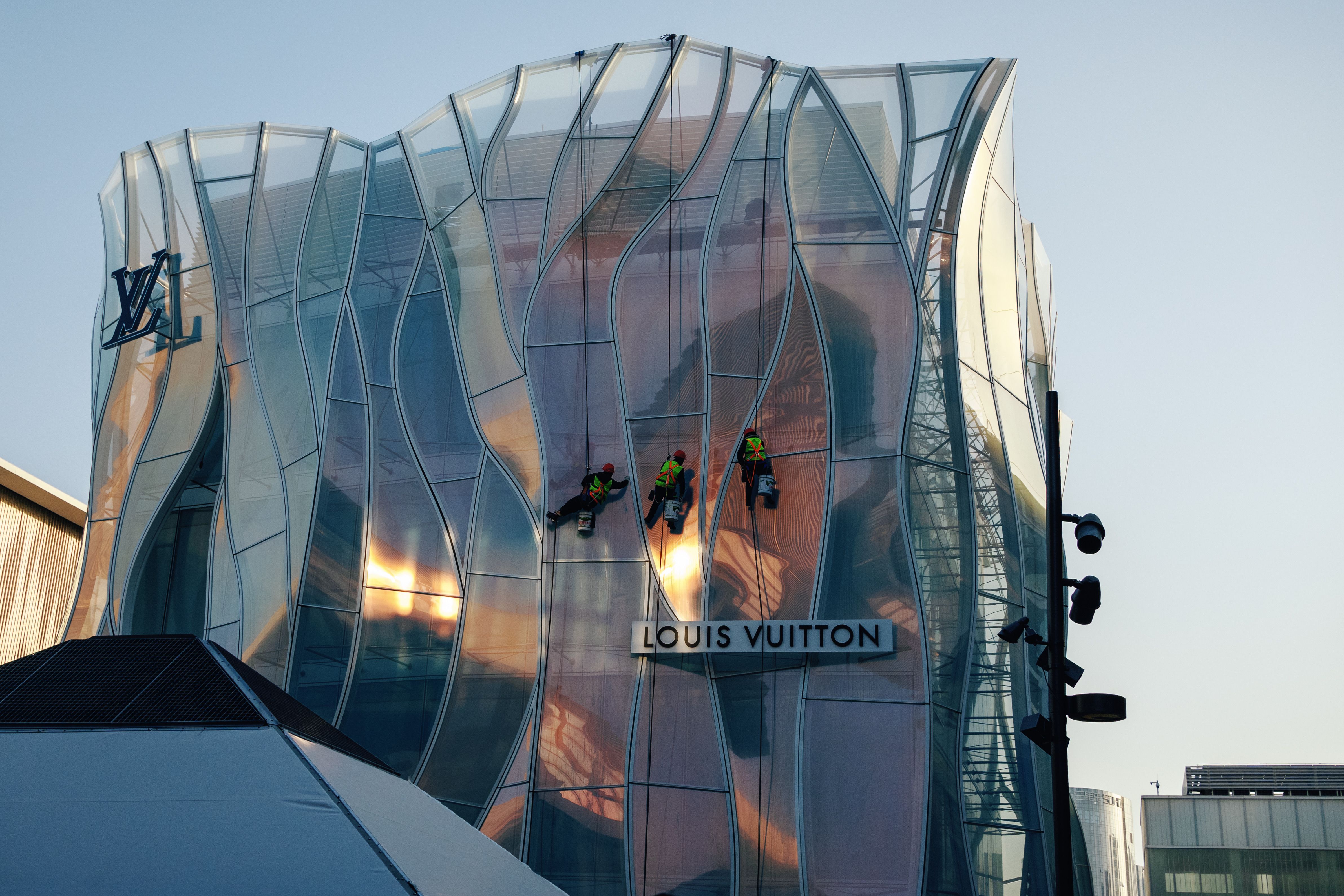 Glass Facade with Workers on Louis Vuitton Building · Free Stock Photo