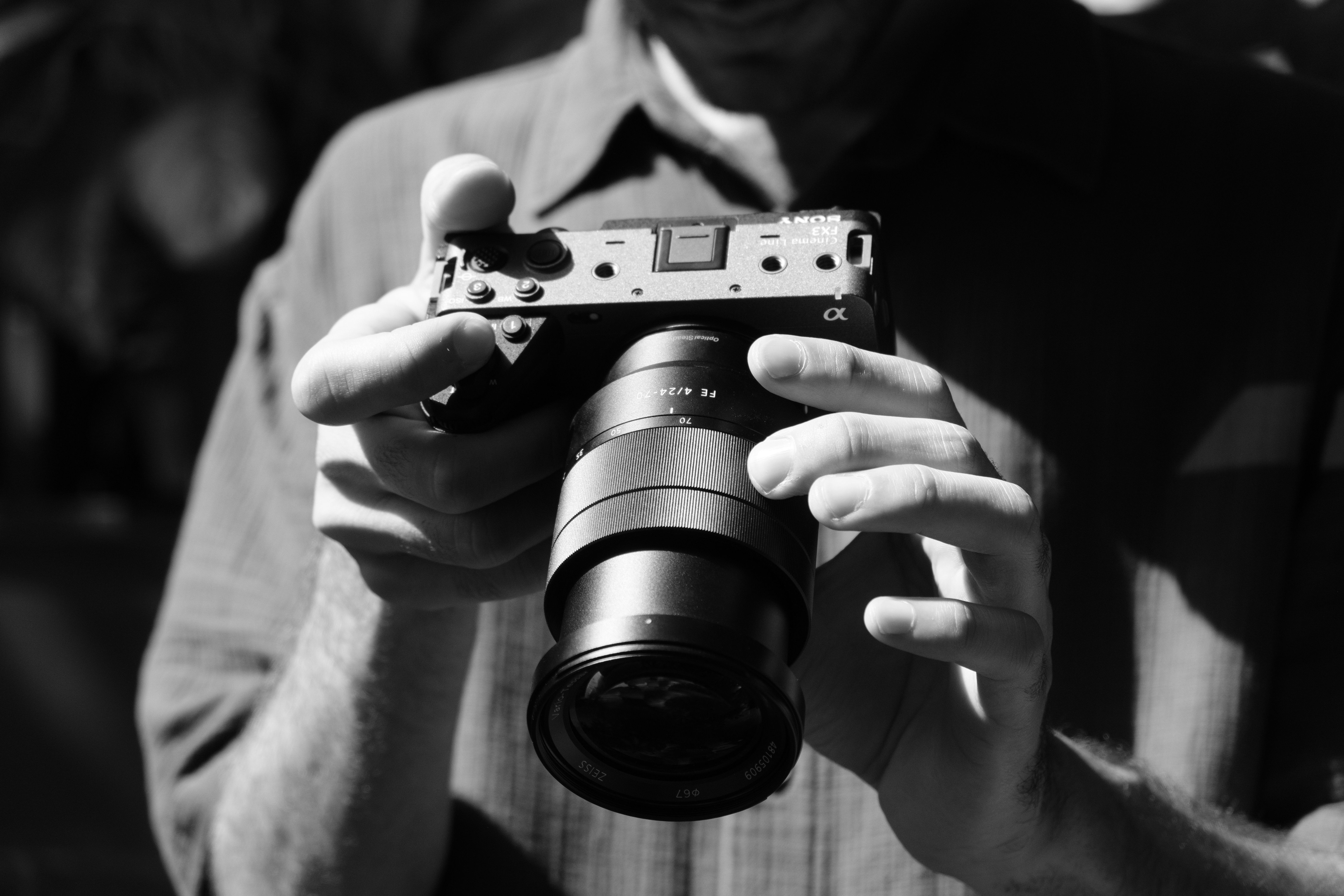 Close-up of Photographer Adjusting Camera Settings · Free Stock Photo