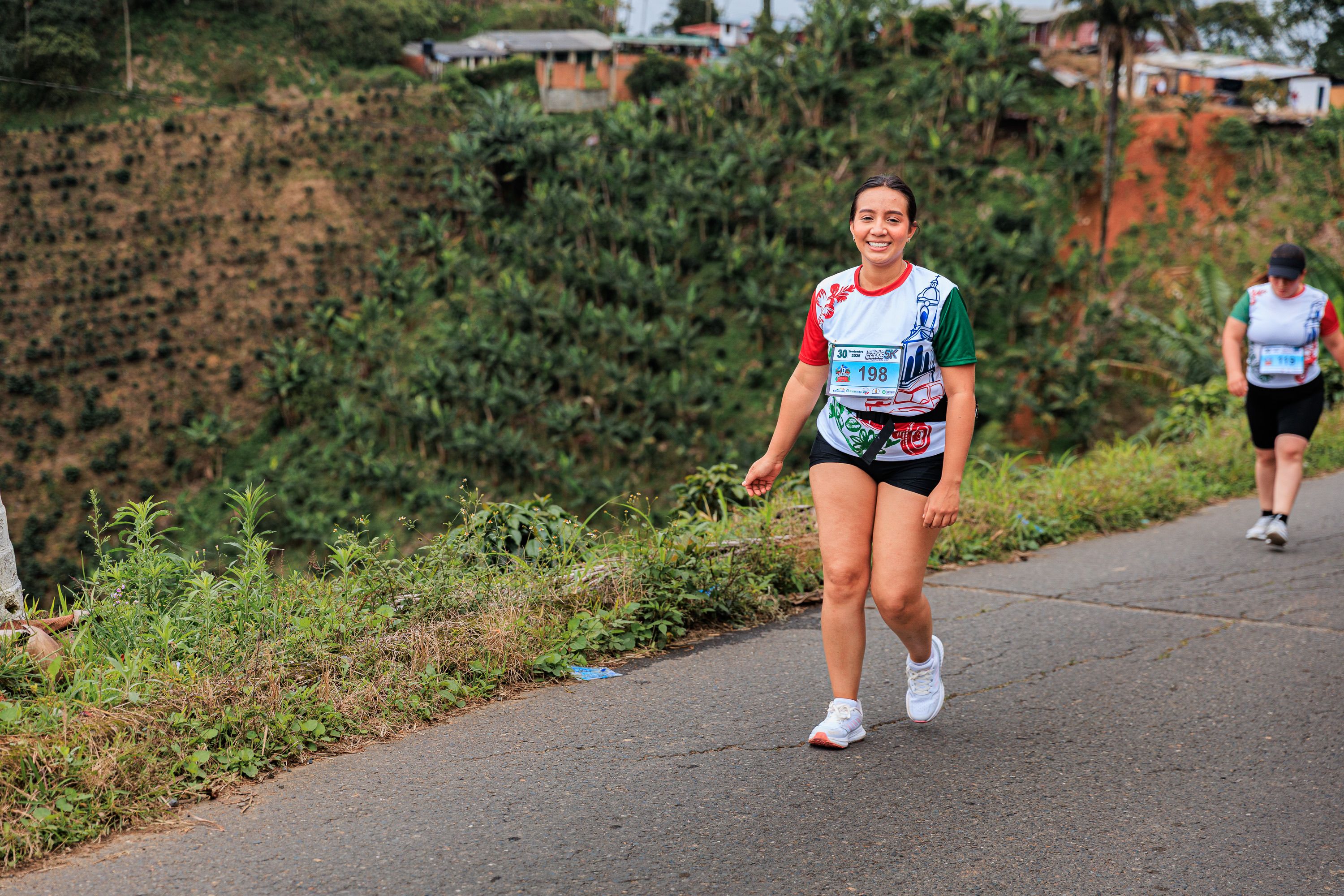 Female Runner Smiling During Outdoor Marathon Event · Free Stock Photo