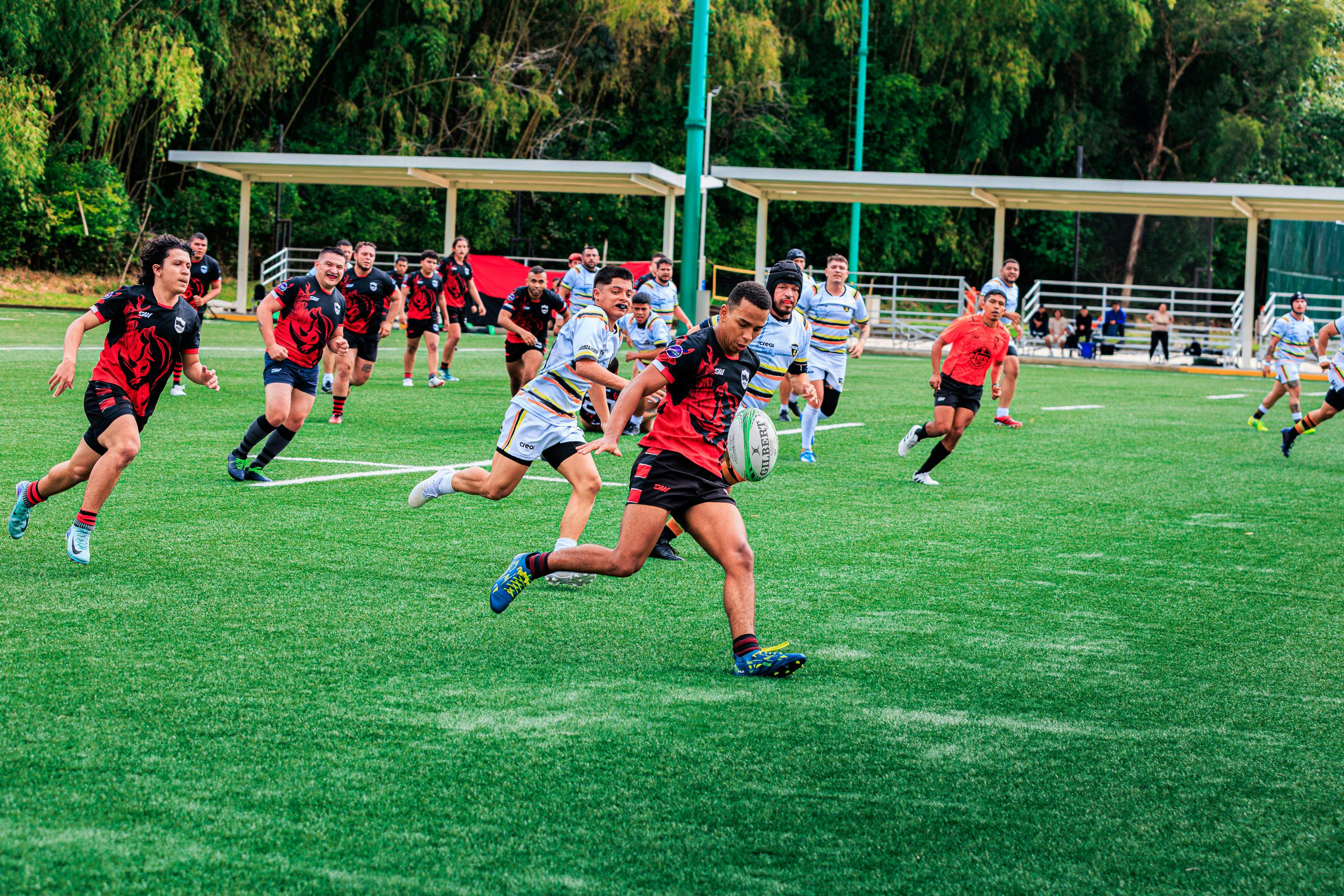 Action-Packed Rugby Match on Green Field · Free Stock Photo