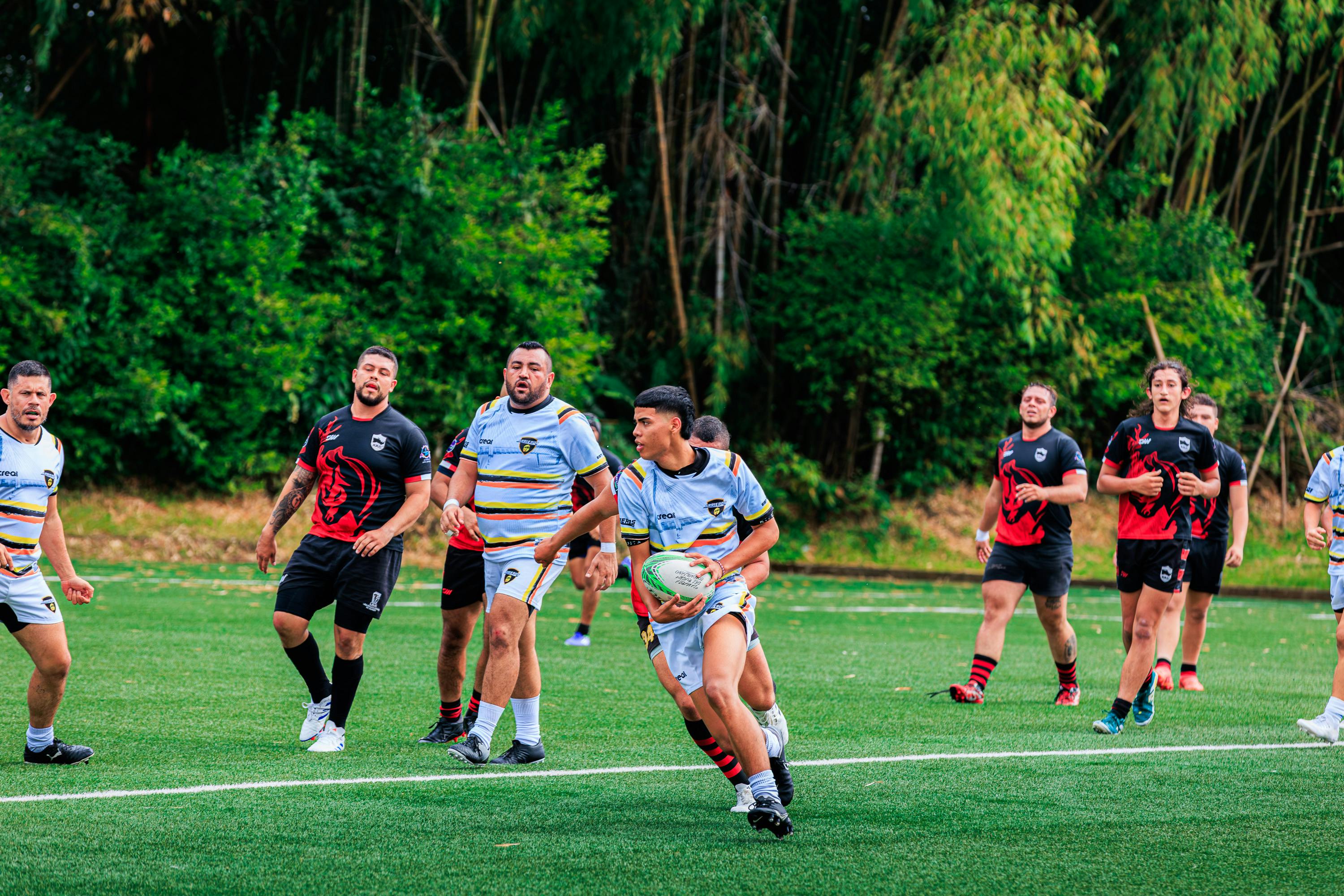 Action-Packed Rugby Match on Green Field · Free Stock Photo