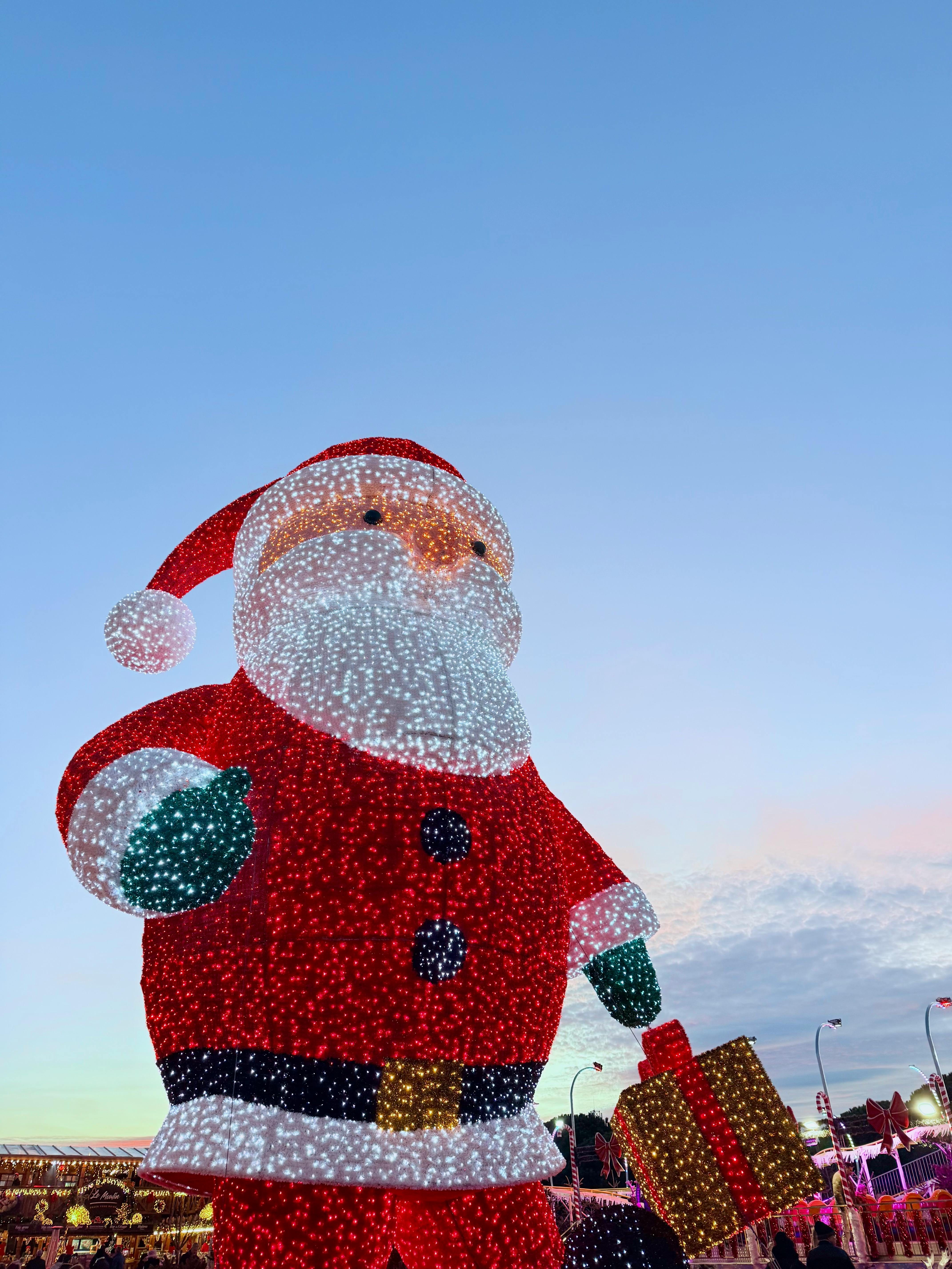Giant Illuminated Santa Claus Display At Dusk Free Stock Photo