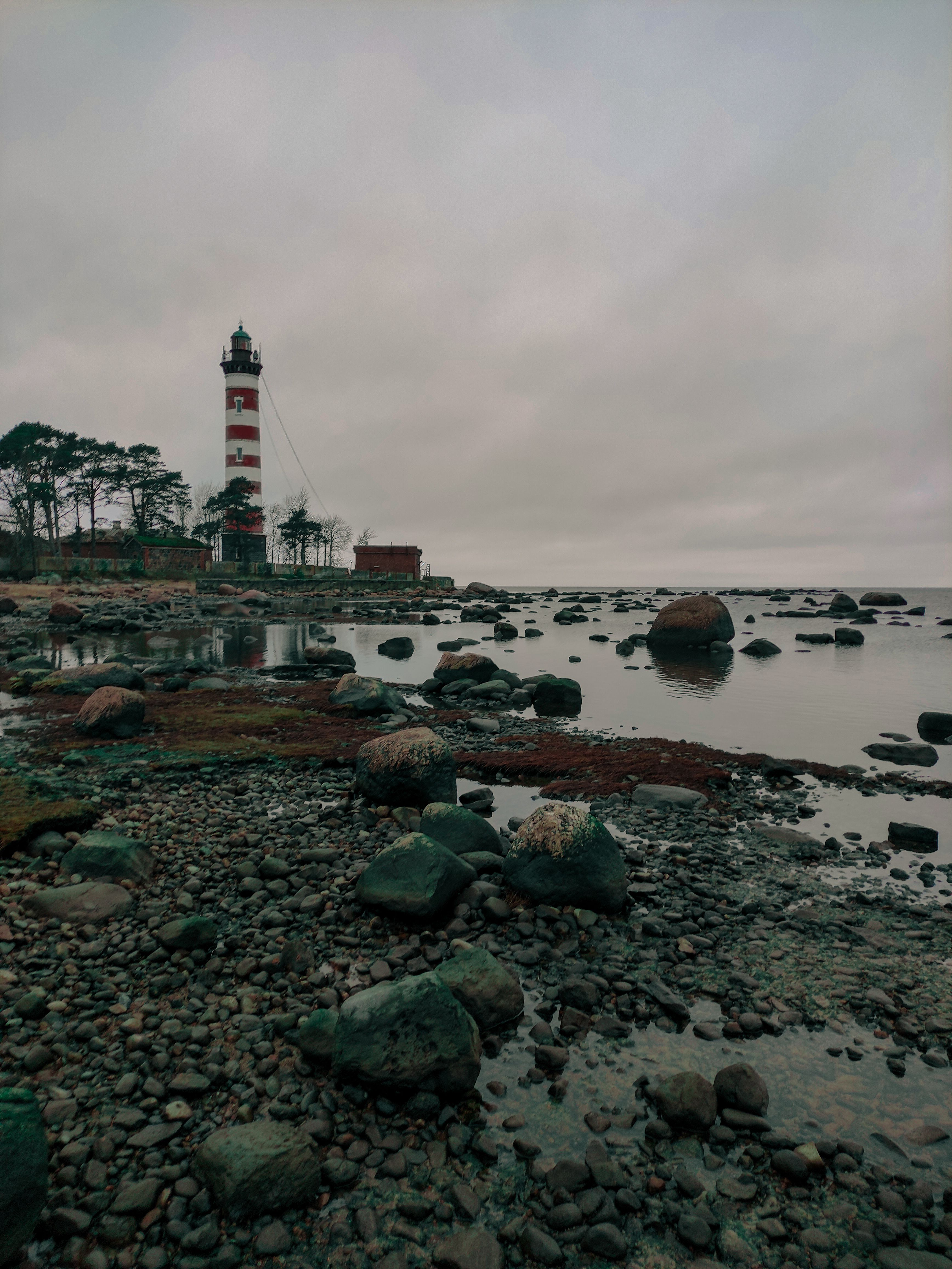 Dramatic Coastal Lighthouse in Overcast Weather · Free Stock Photo