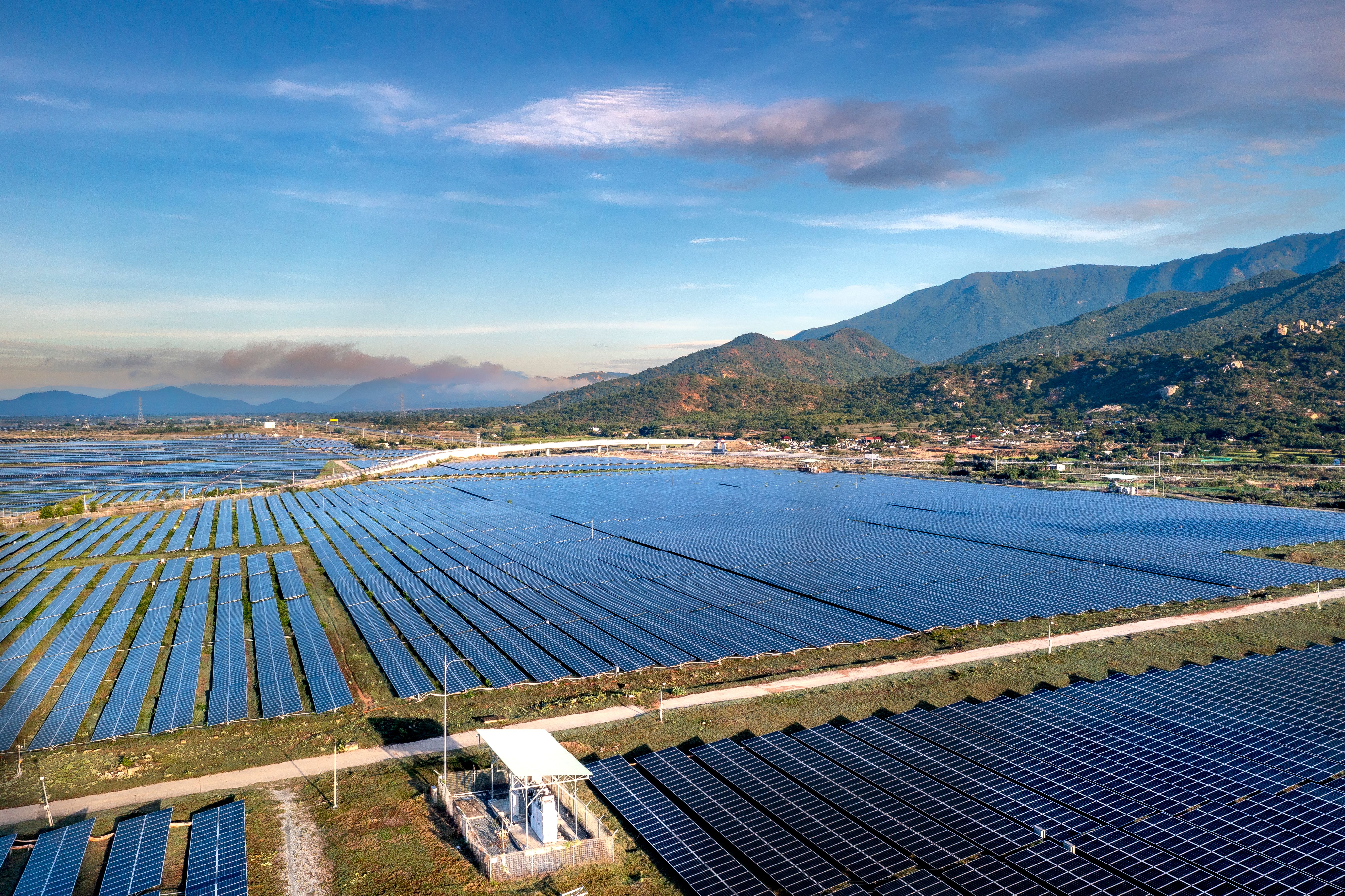 Aerial View of Solar Farm with Mountain Background · Free Stock Photo