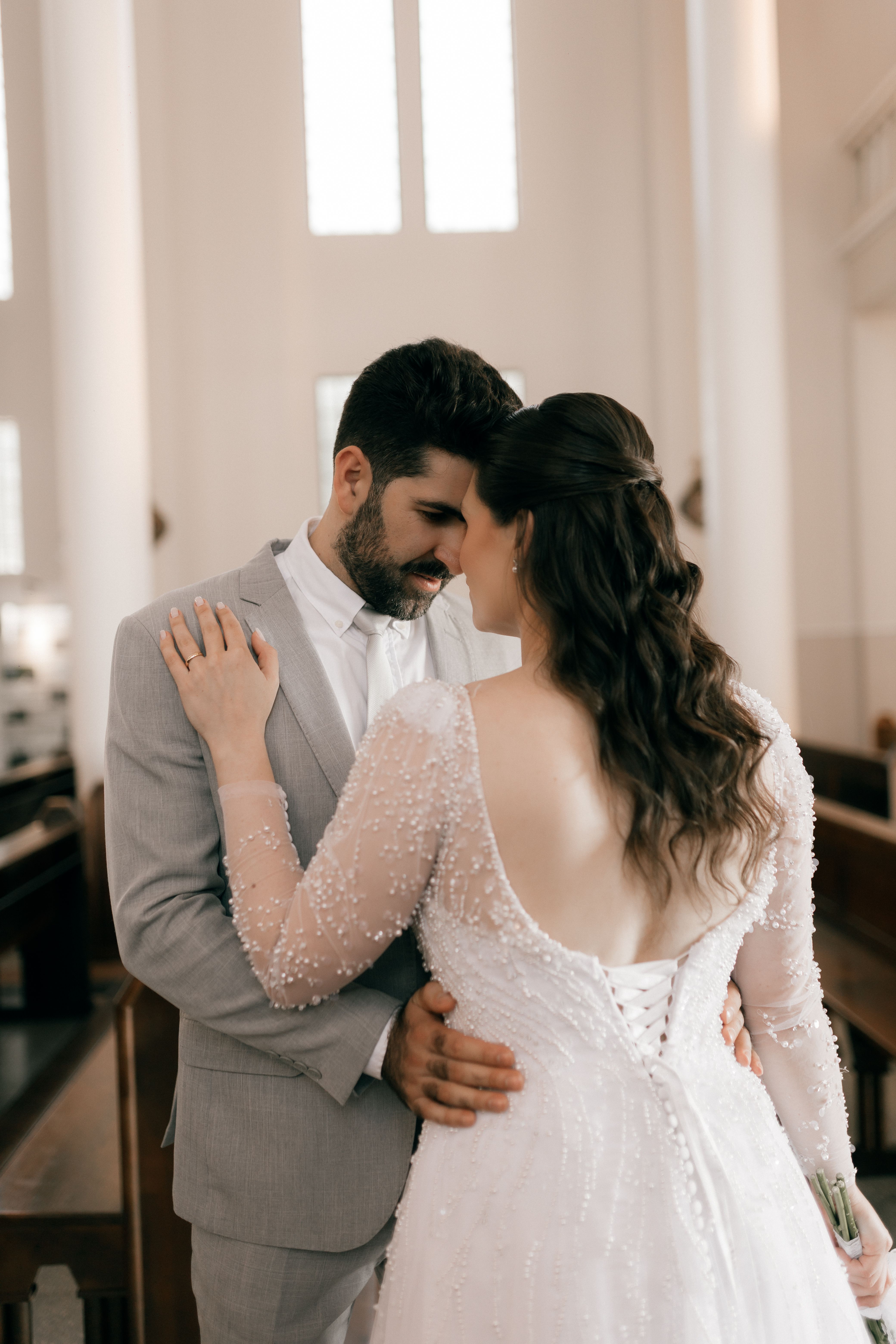 Intimate Bride and Groom Embrace in Church Setting · Free Stock Photo