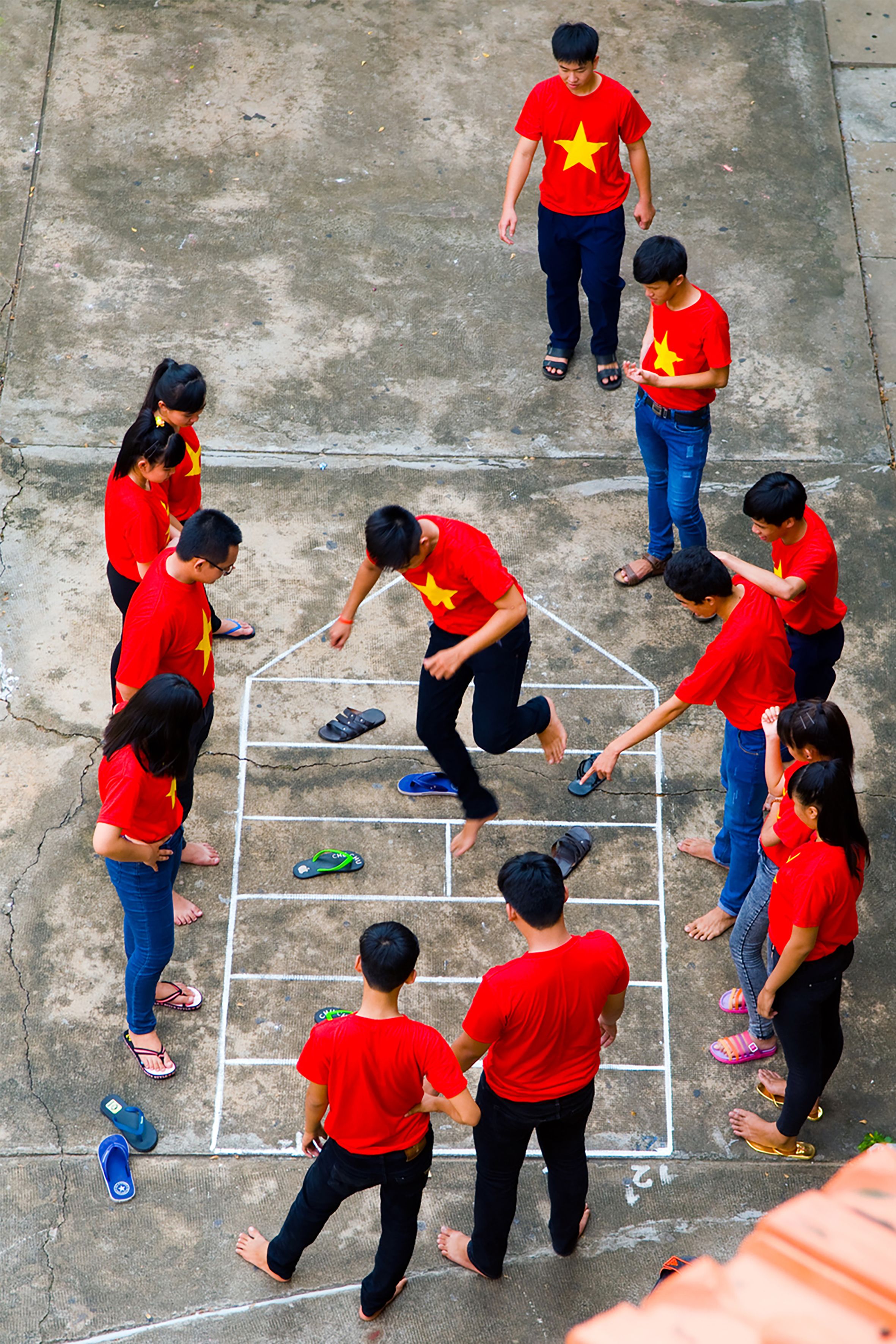 Group Playing Traditional Hopscotch Game Outdoors · Free Stock Photo