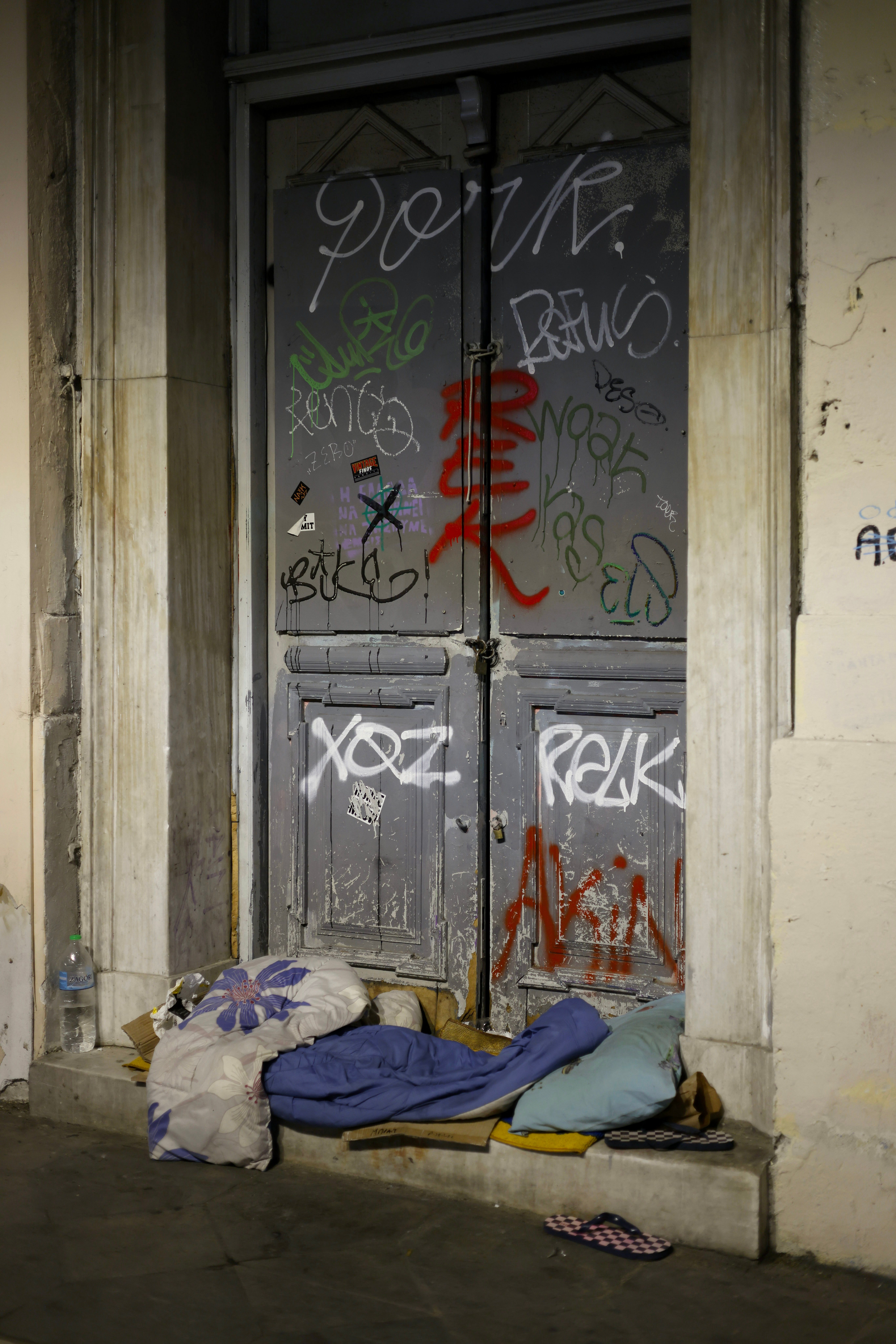 Urban Street Scene with Graffiti and Sleeping Area · Free Stock Photo