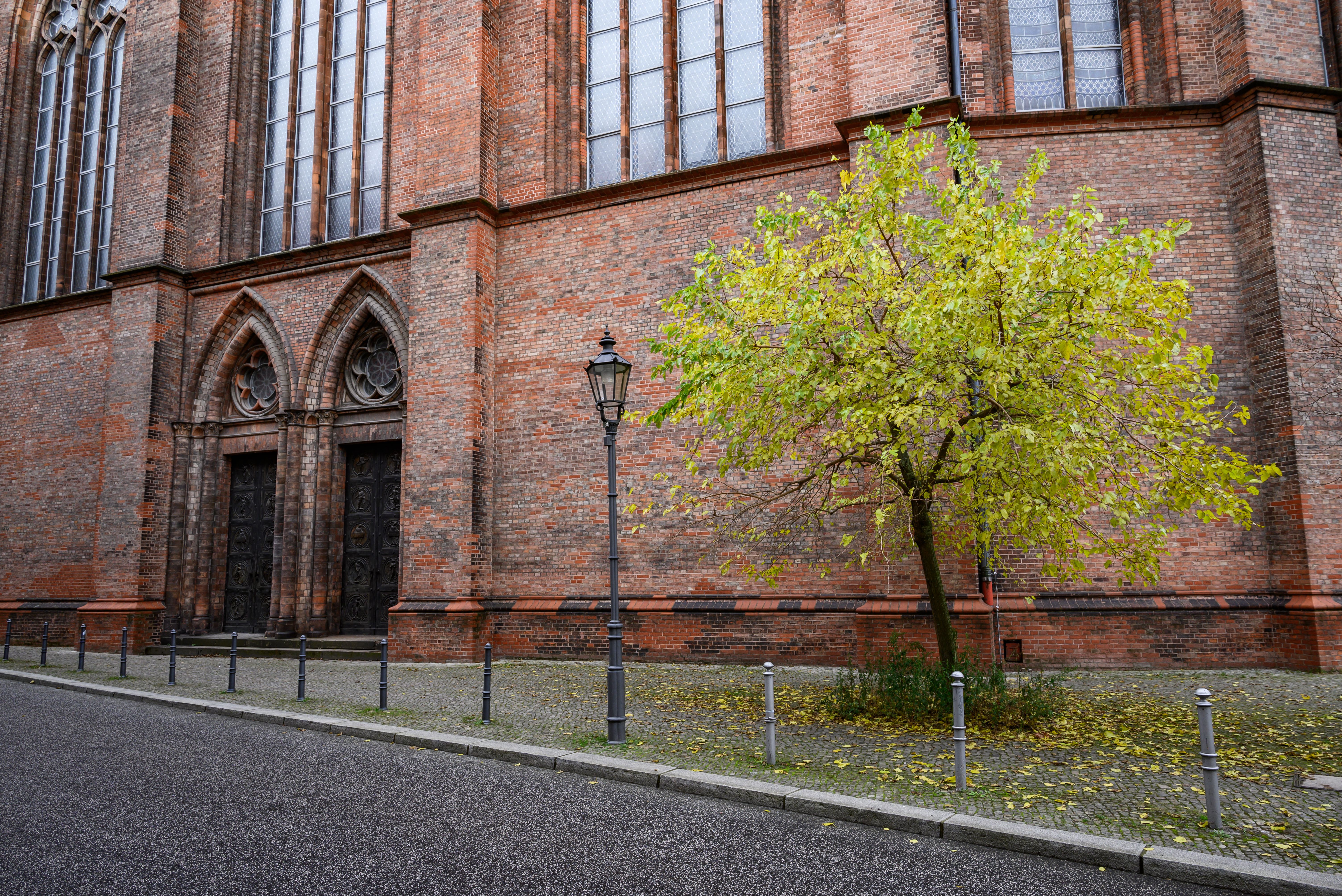 Gothic Church Facade with Autumn Tree in Berlin · Free Stock Photo