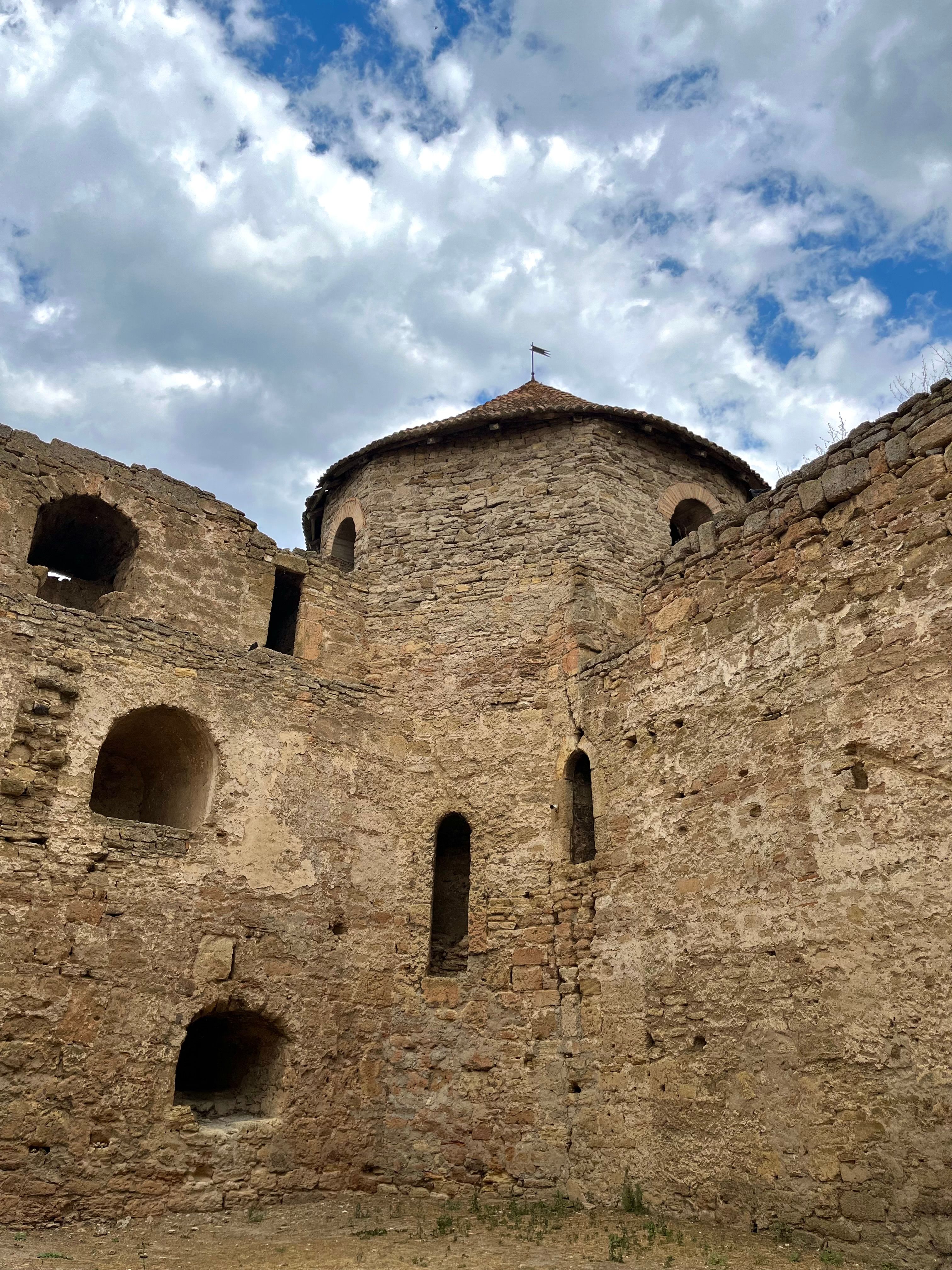 Historic Stone Fortress Under a Cloudy Sky · Free Stock Photo