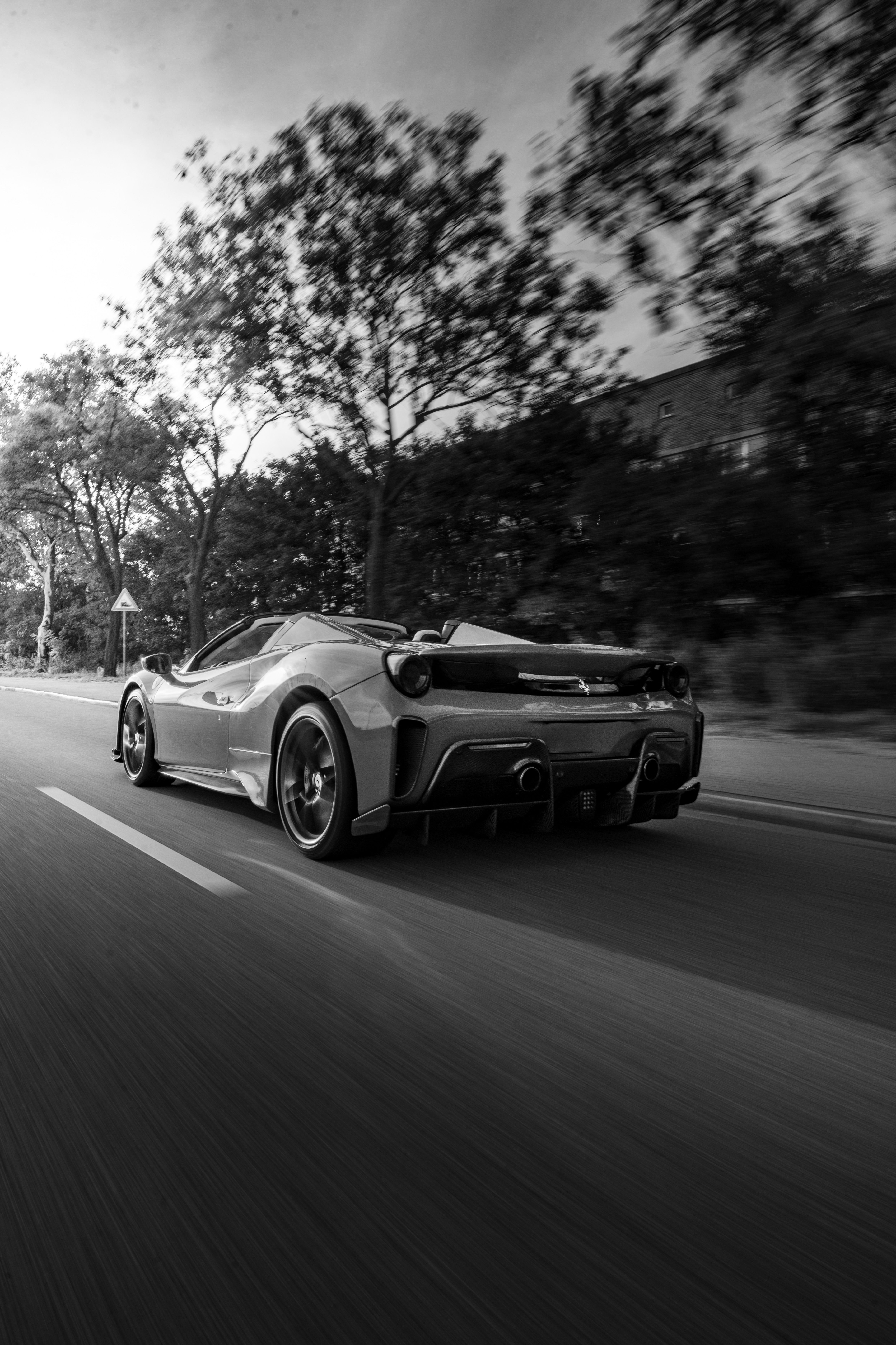 Sleek Ferrari on Scenic Urban Roadway · Free Stock Photo
