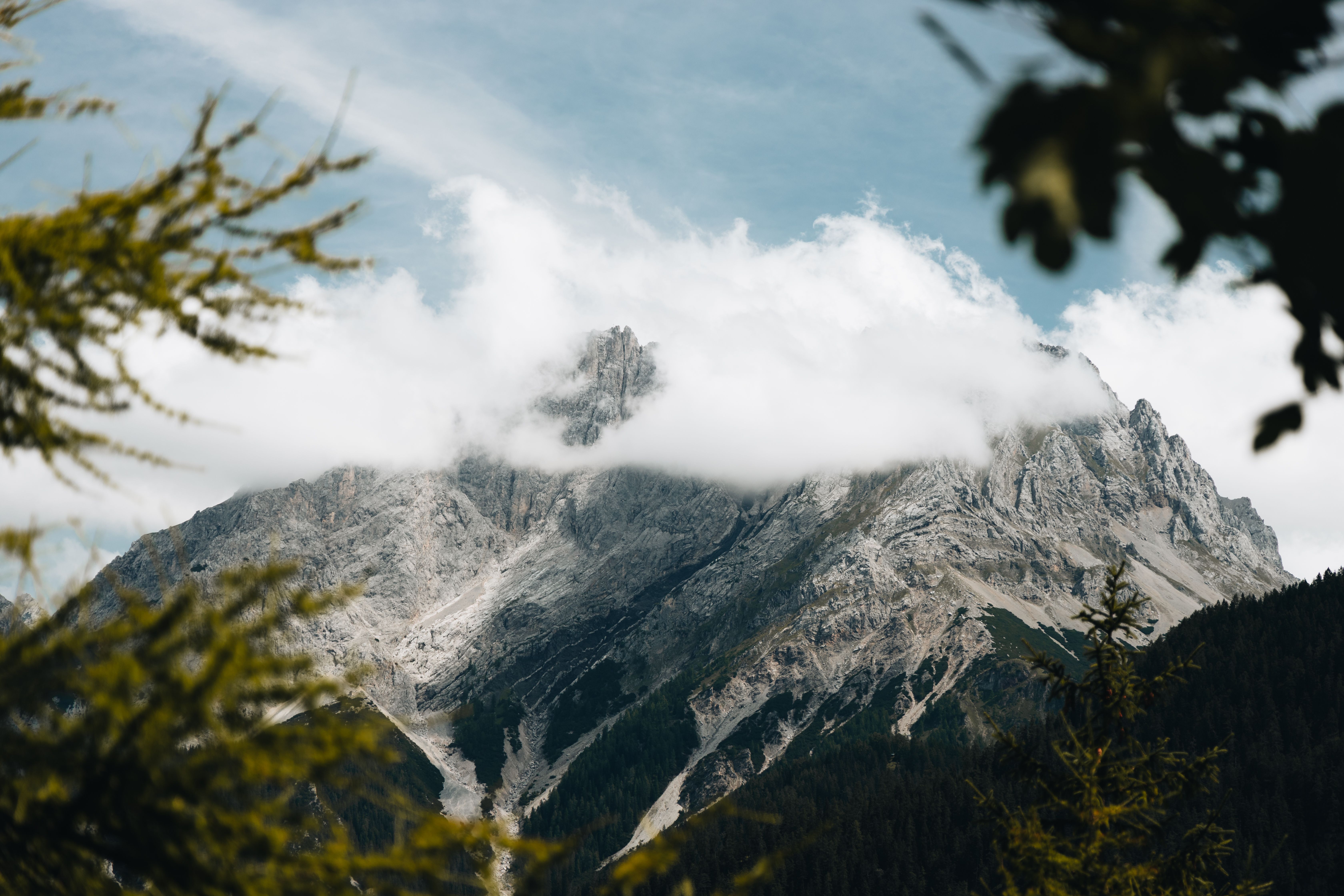 Majestic Mountain Peaks Under Cloudy Skies · Free Stock Photo