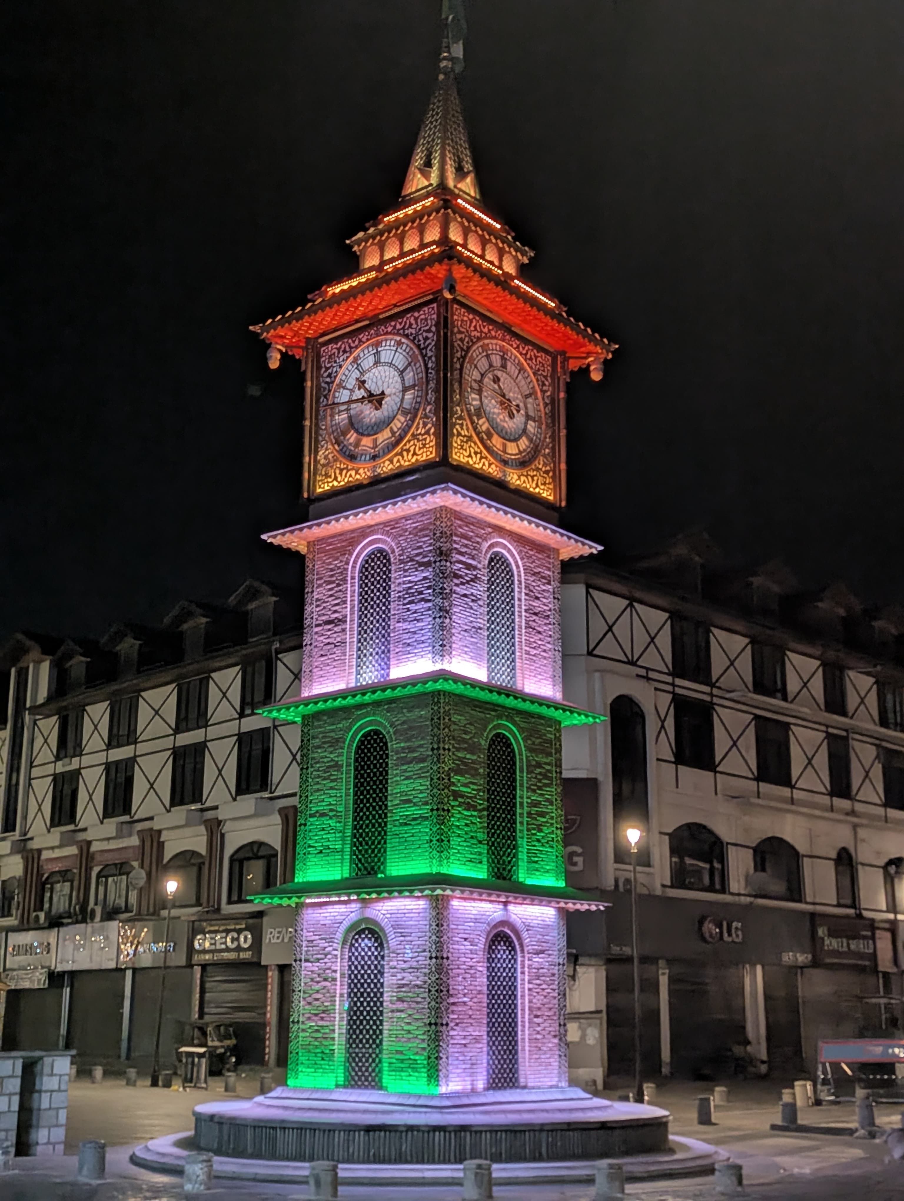 Illuminated Clock Tower at Night with Tricolor Lights · Free Stock Photo