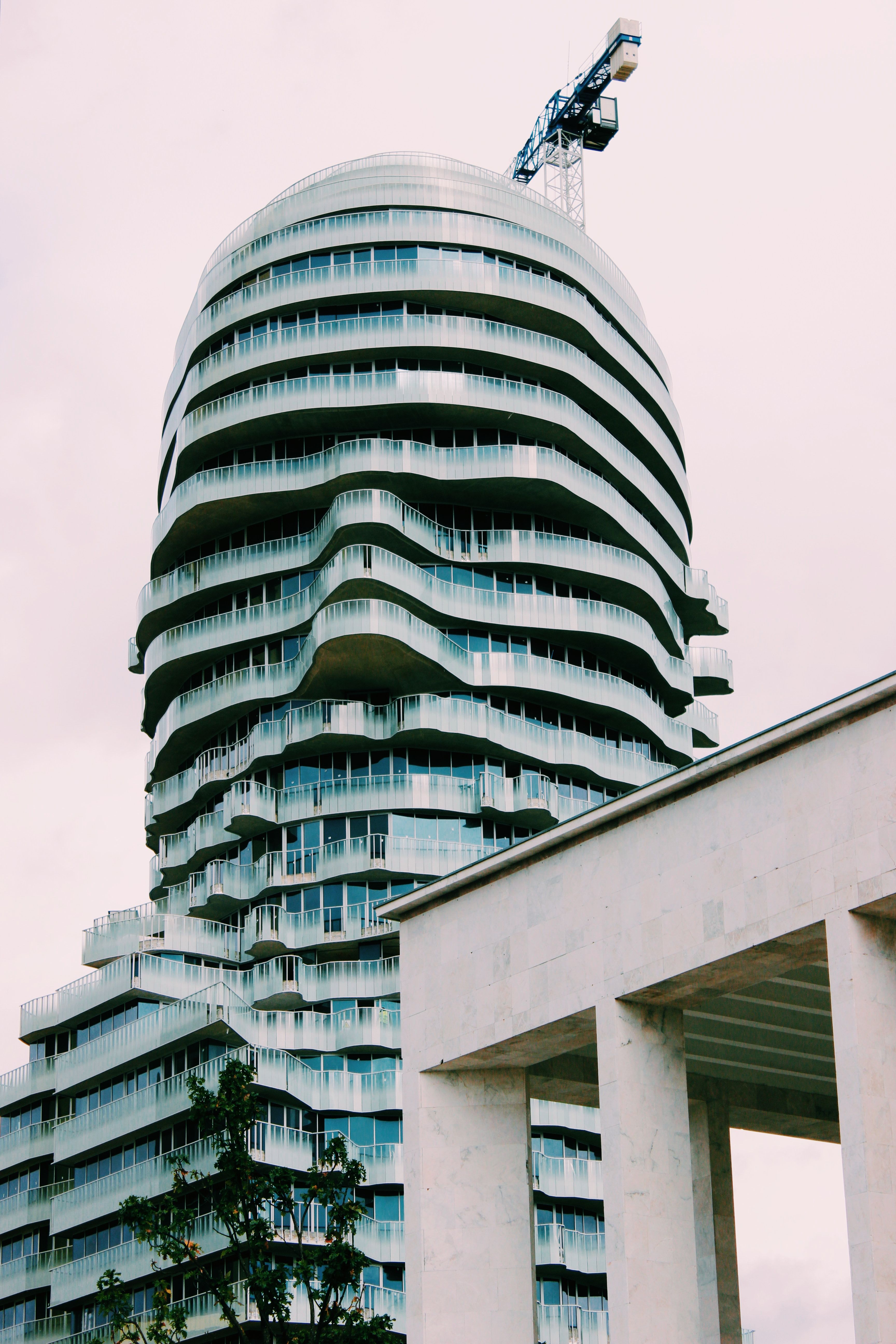Modern Curved Architectural Tower Against Sky · Free Stock Photo