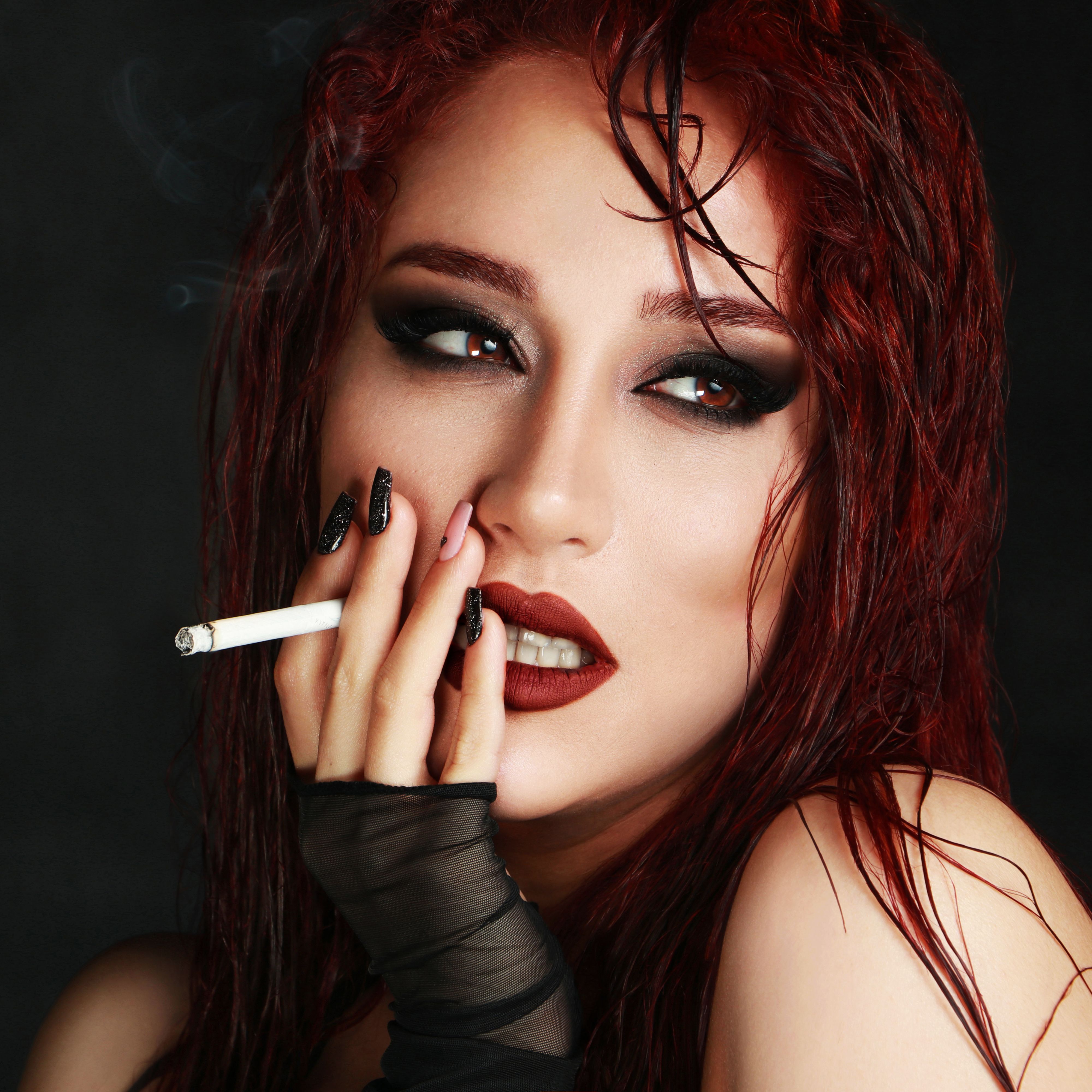 Glamorous Woman Smoking with Dramatic Makeup · Free Stock Photo