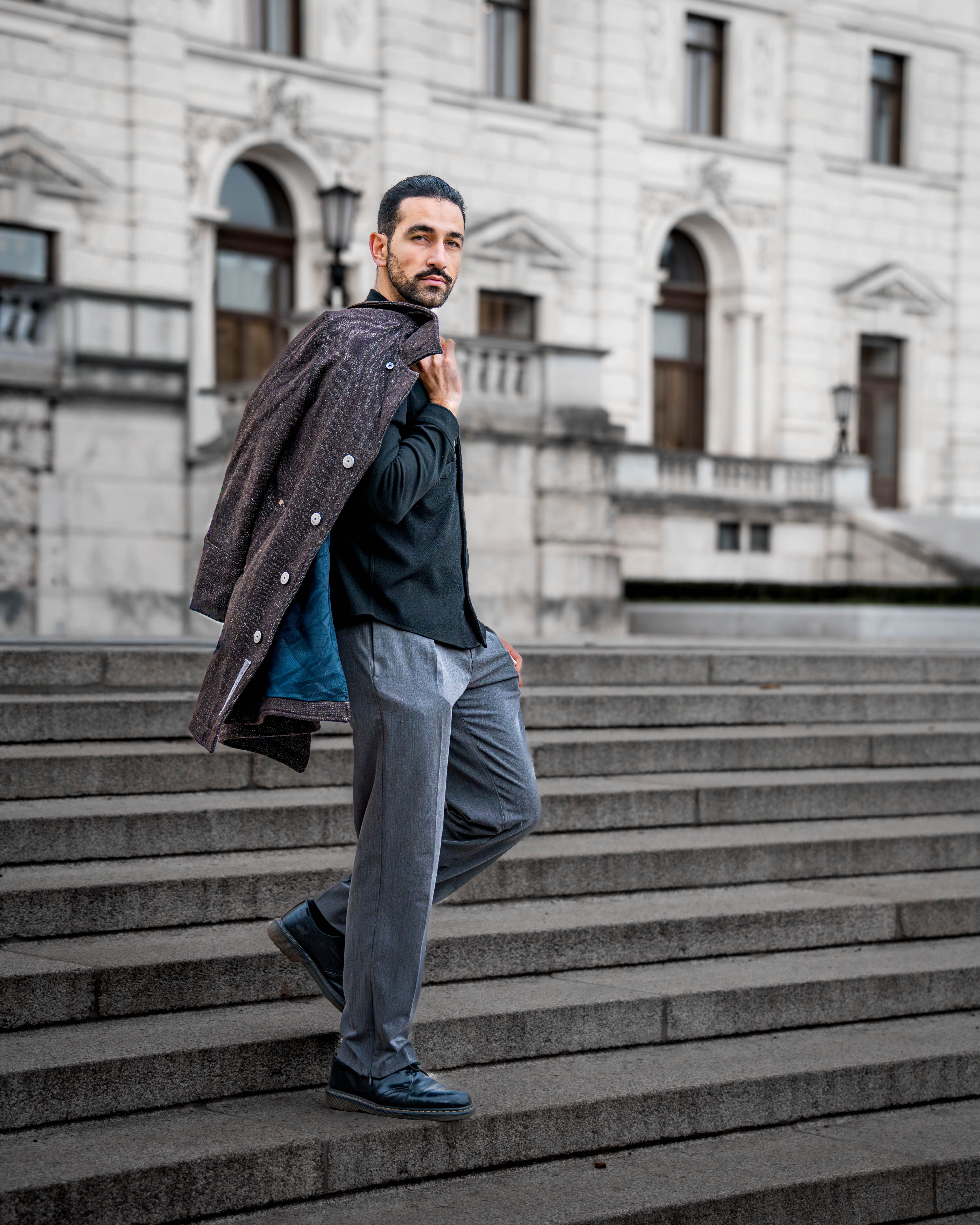 Elegant Male Model Posing on Vienna Steps · Free Stock Photo