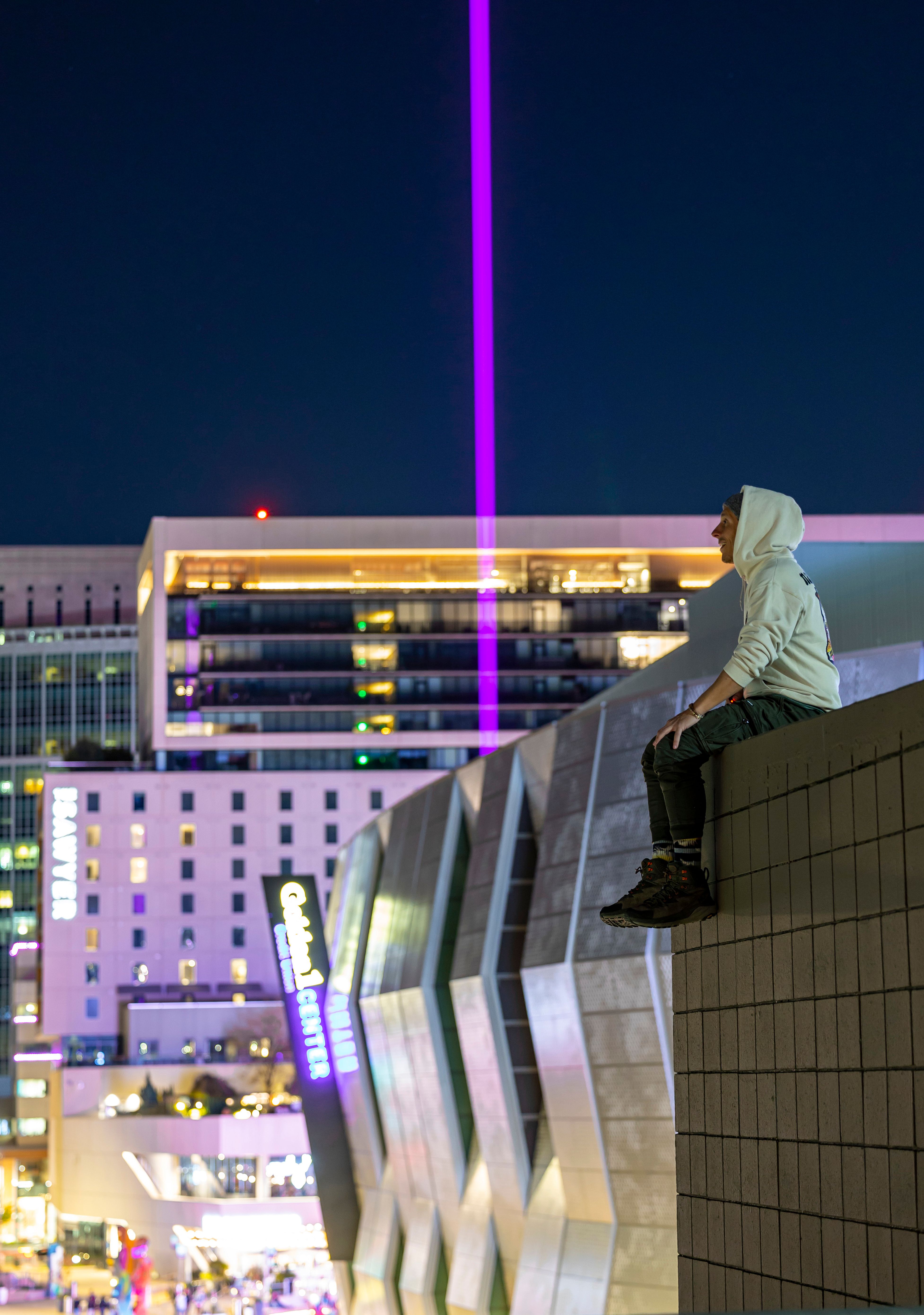 Urban Nightscape with Person Sitting on Rooftop · Free Stock Photo