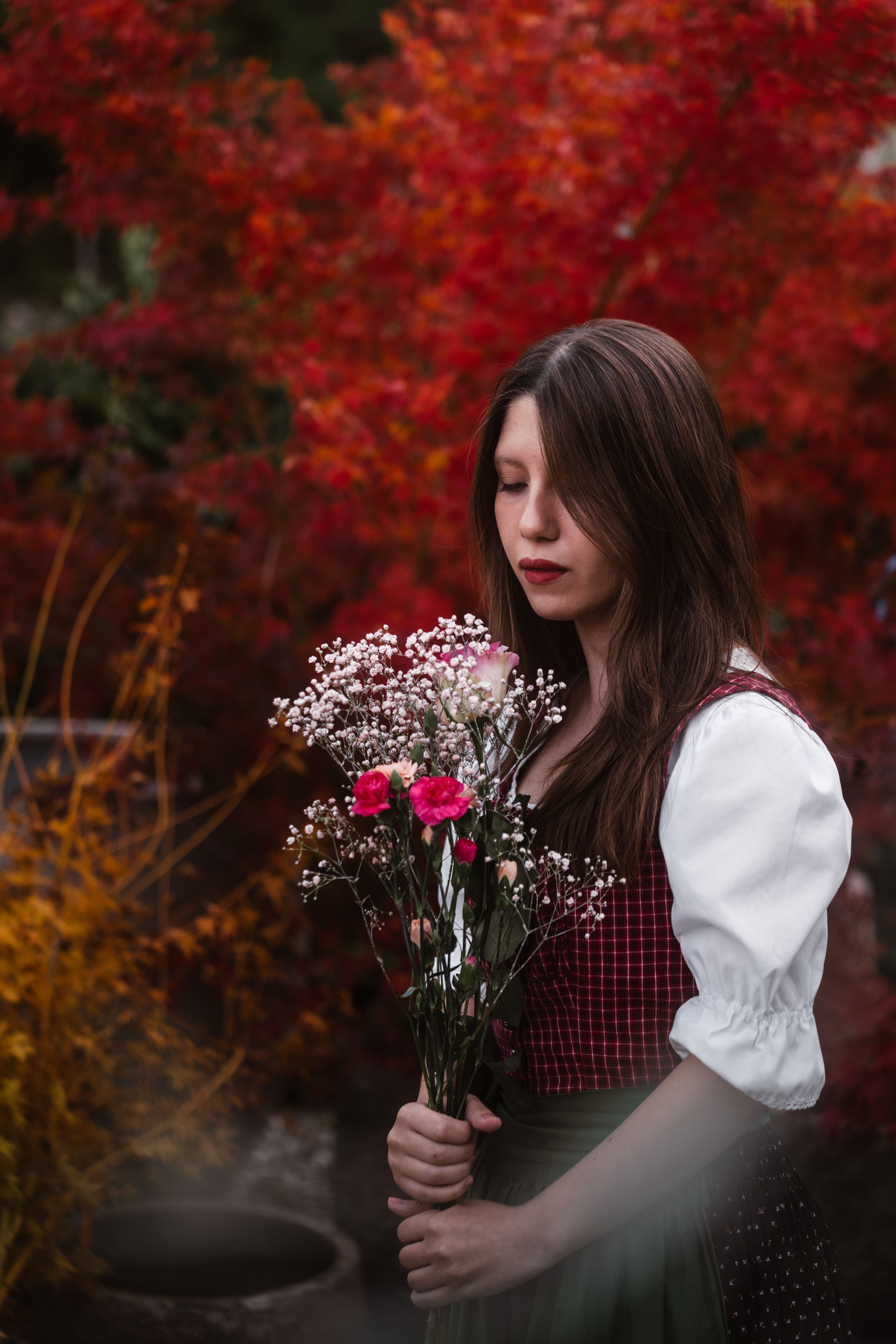 Woman in Traditional Austrian Dress with Flowers · Free Stock Photo