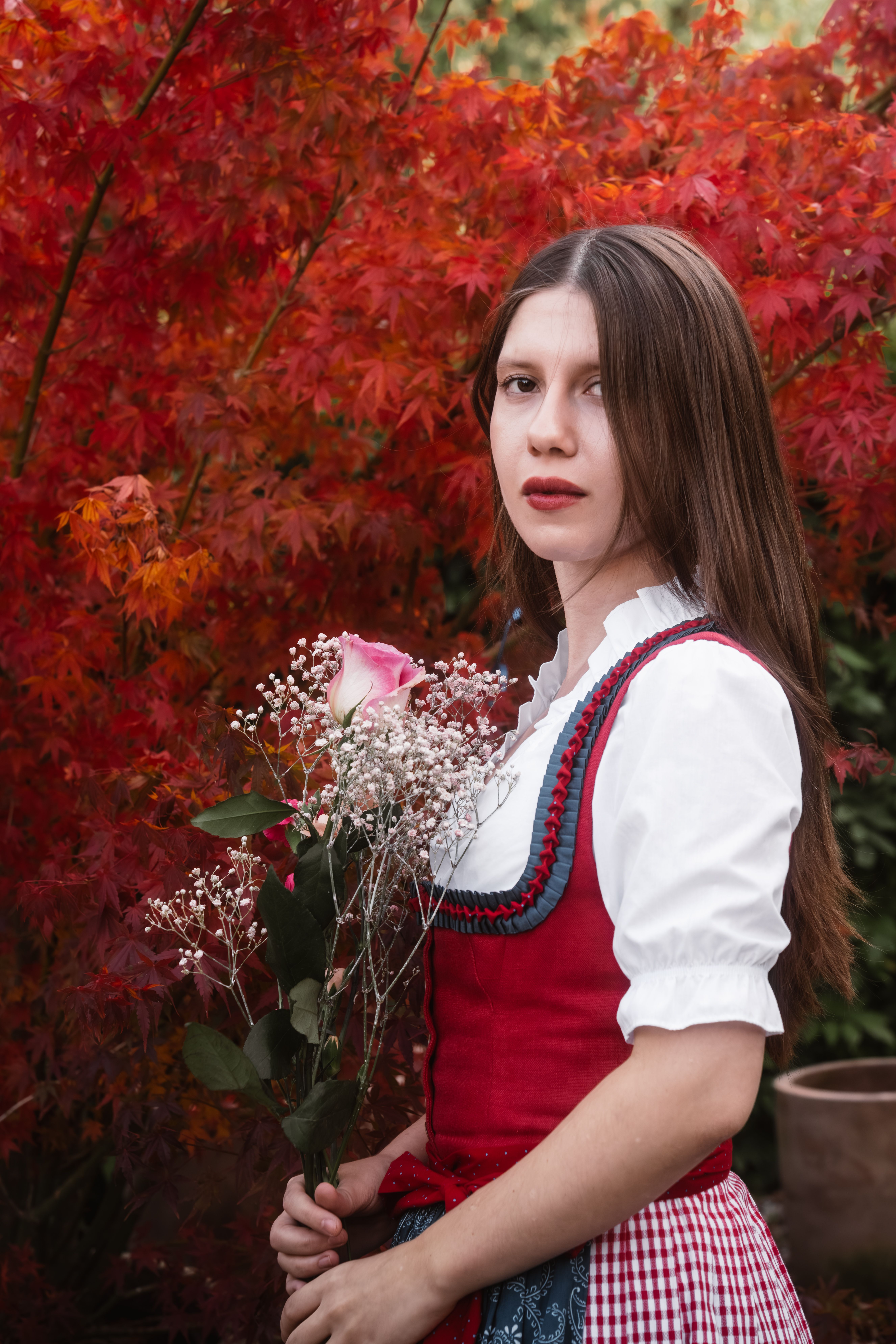 Austrian Woman in Traditional Dress Holding Flowers · Free Stock Photo