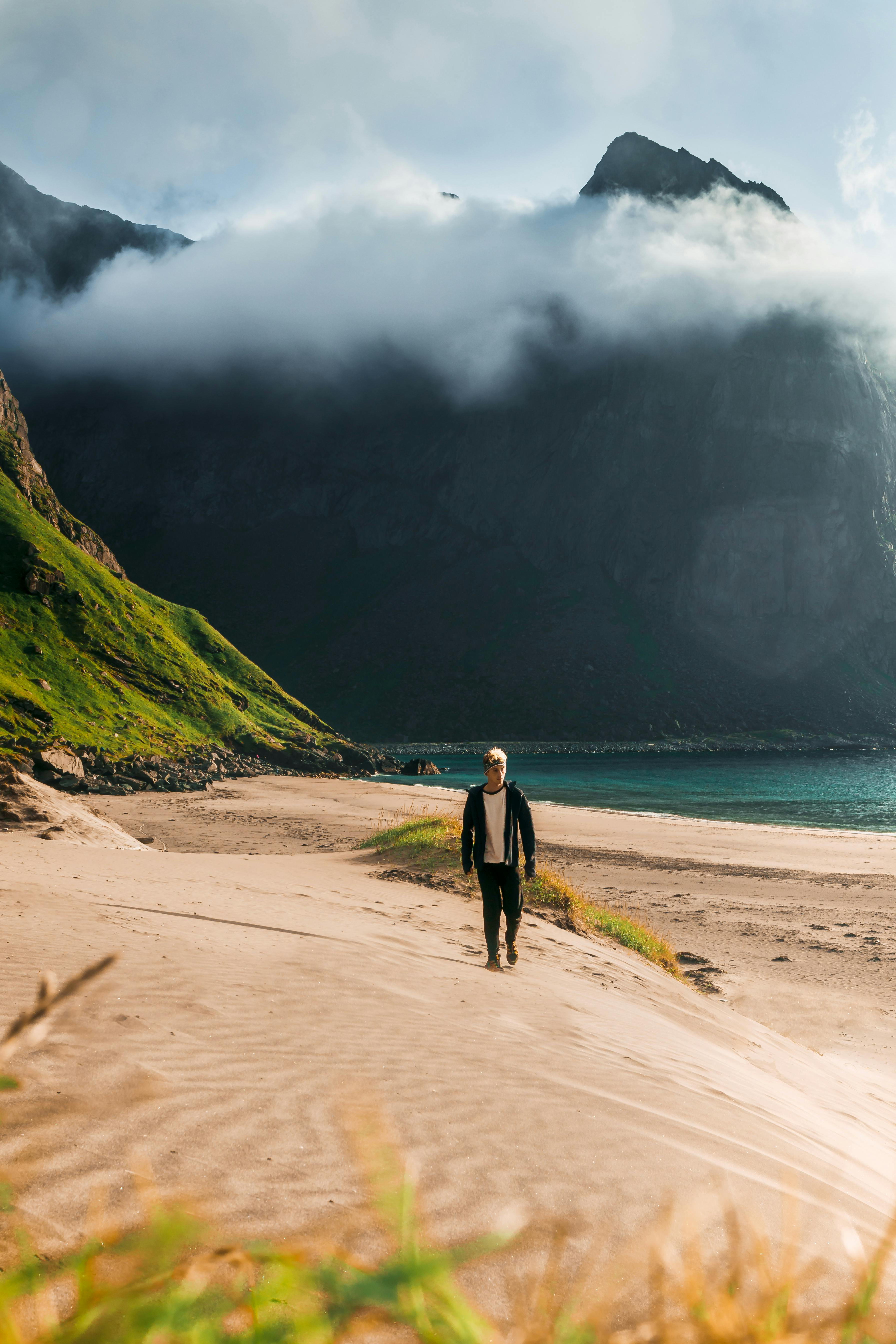 Man Walking On Sand Beside Seashore · Free Stock Photo