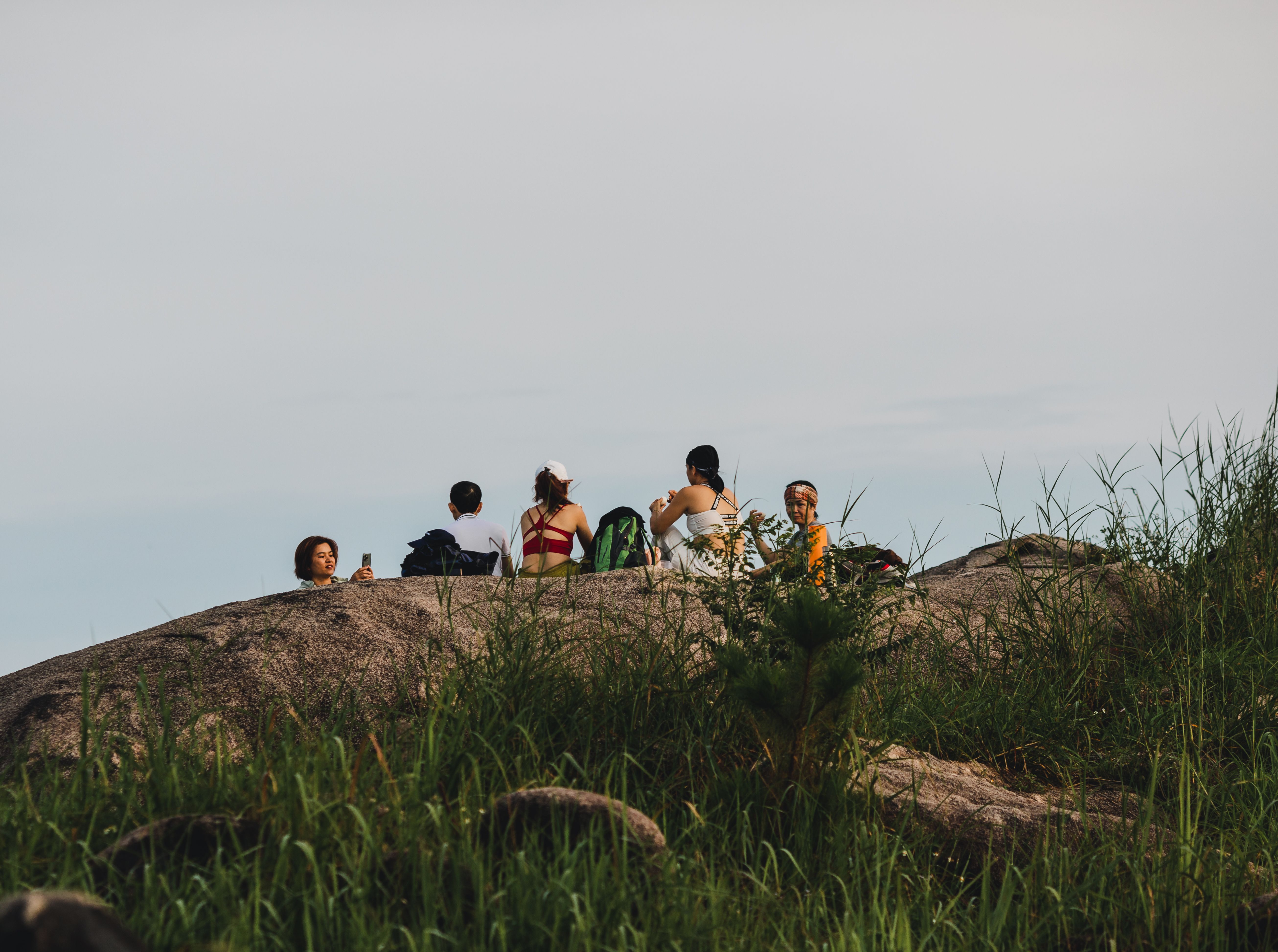 Group of Friends Gathering on Rock Outdoors · Free Stock Photo