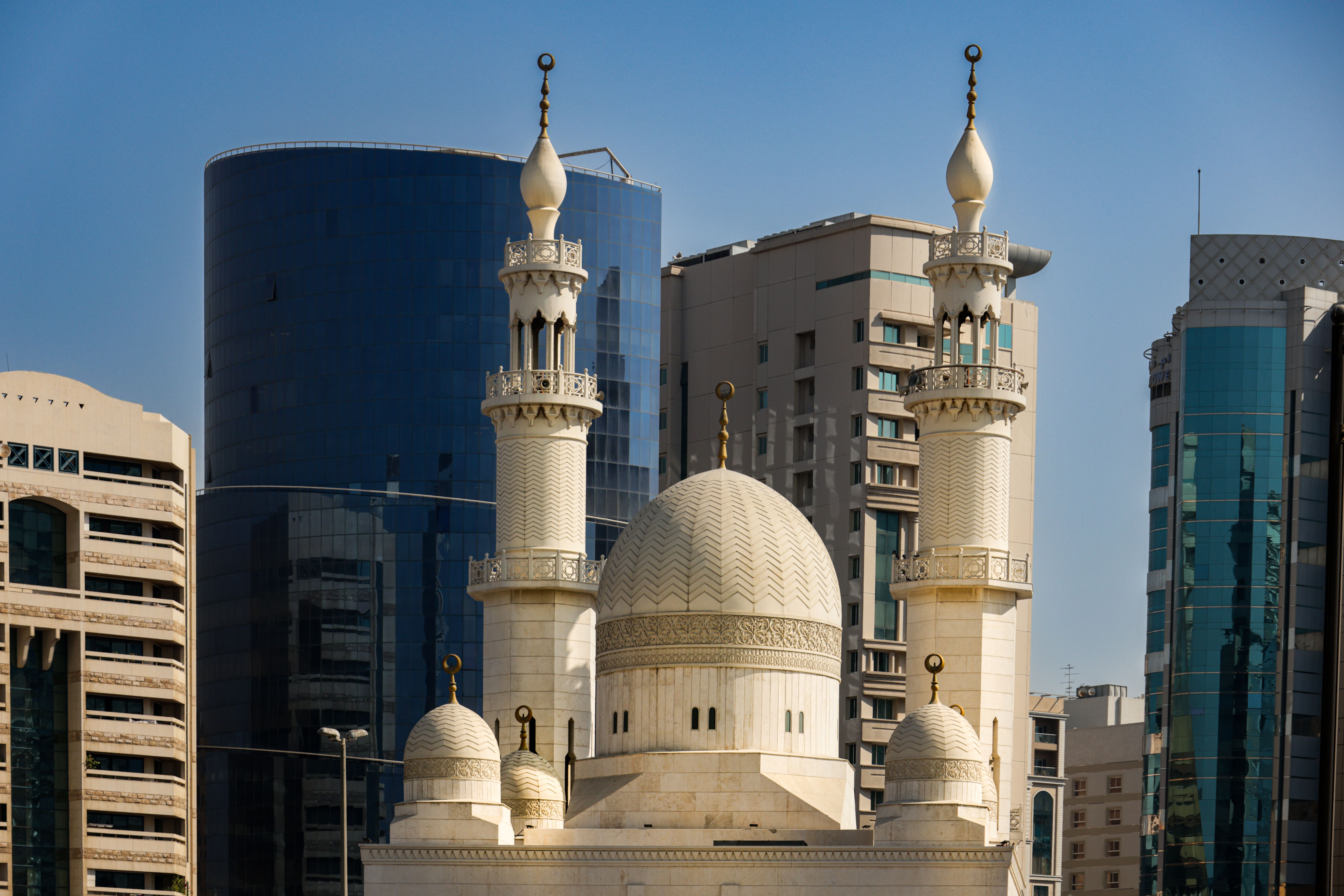 Modern Cityscape with Prominent Mosque Minarets · Free Stock Photo