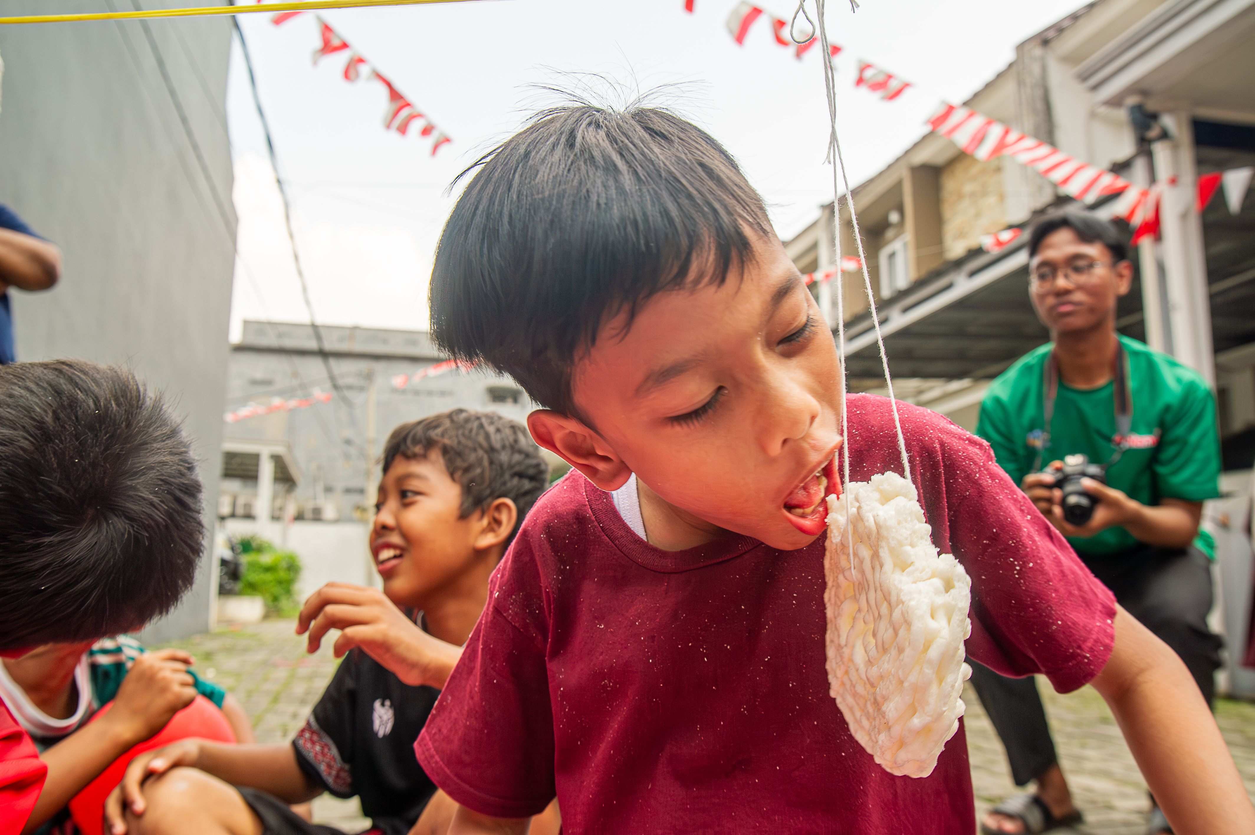 Boy participating in traditional cracker eating contest · Free Stock Photo