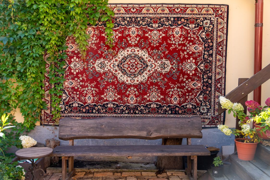 Rustic Bench and Persian Rug in Garden Setting · Free Stock Photo