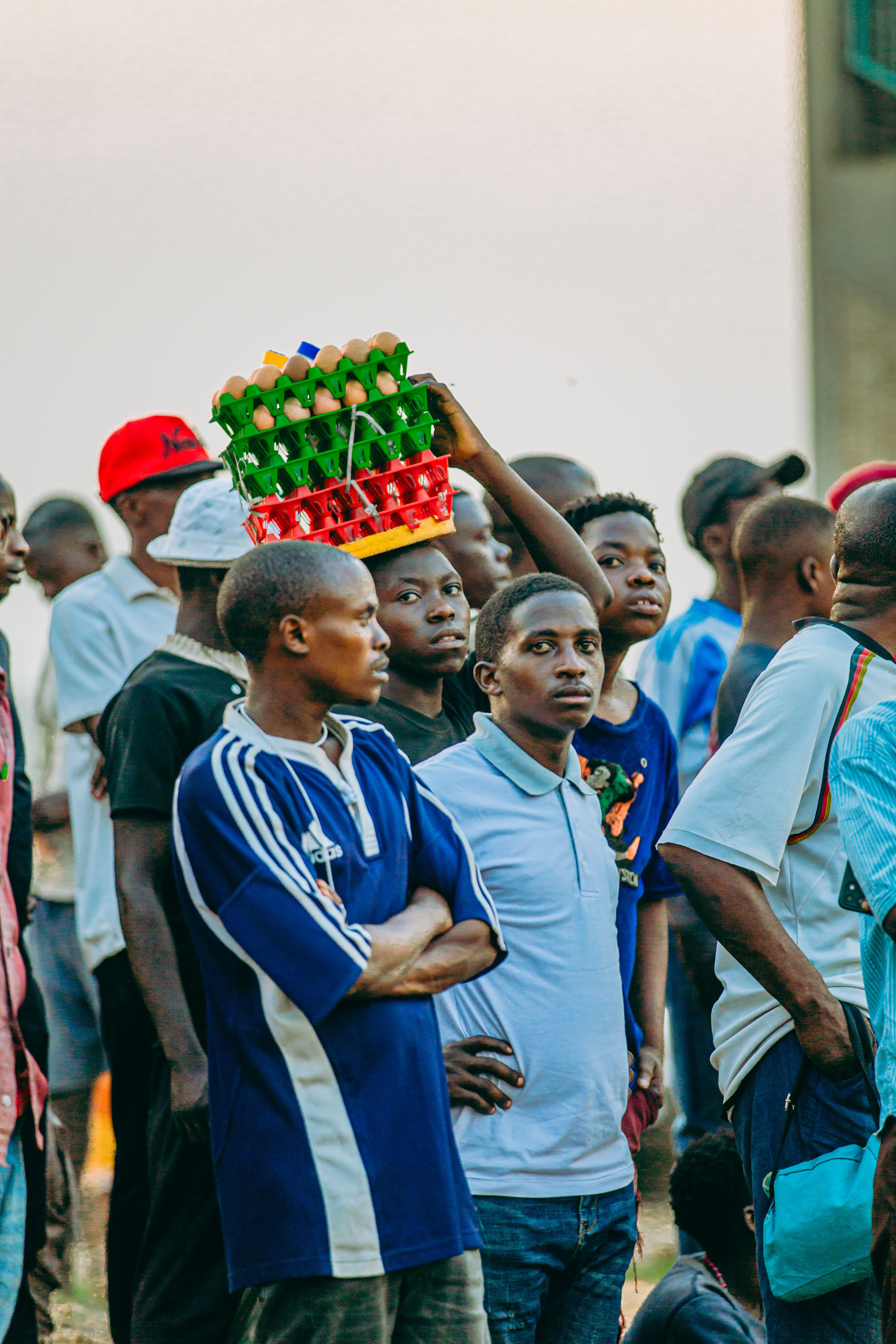 Crowd Scene with Street Vendor Carrying Merchandise · Free Stock Photo