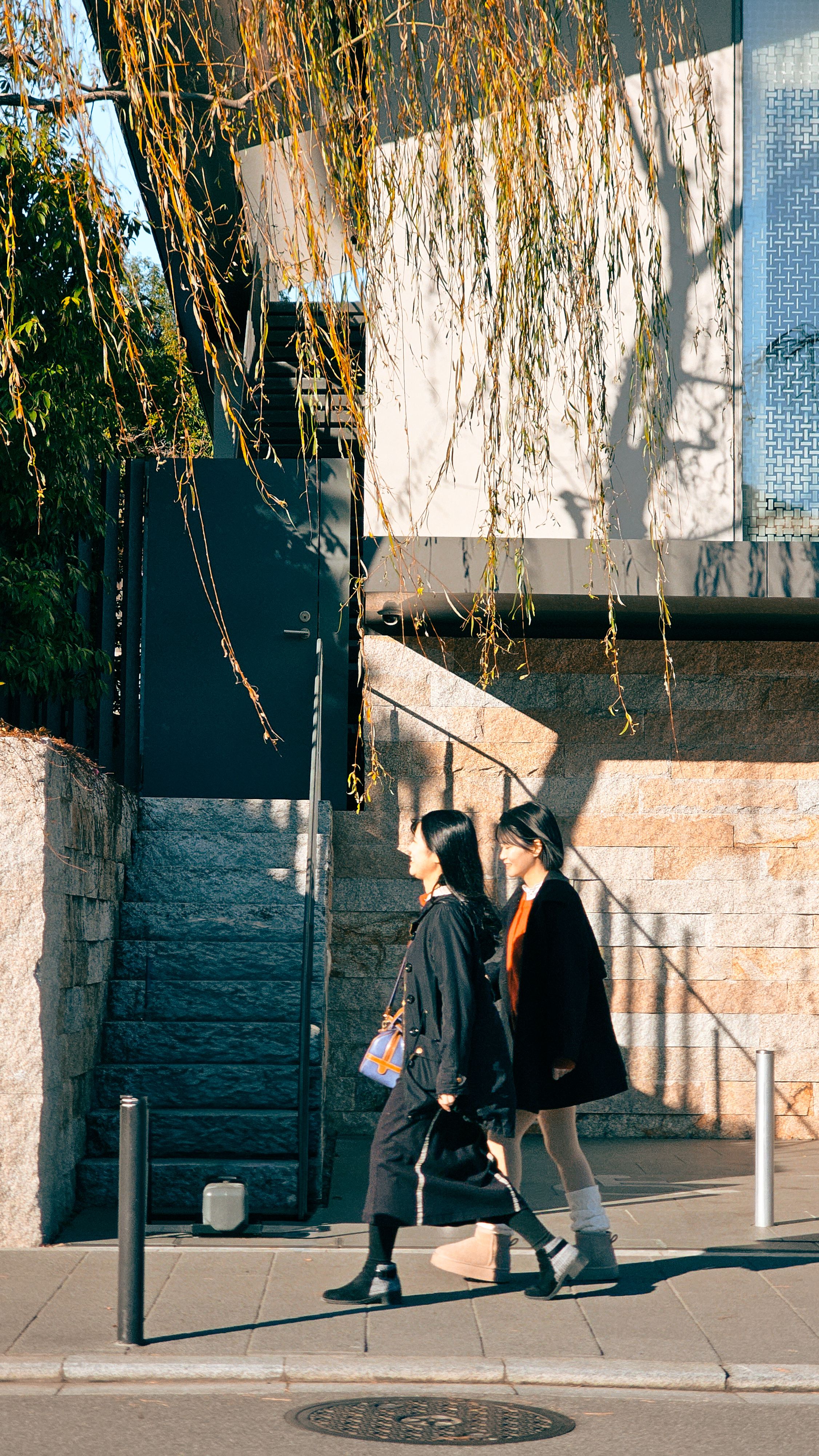 Stylish Women Walking by Modern Urban Architecture · Free Stock Photo