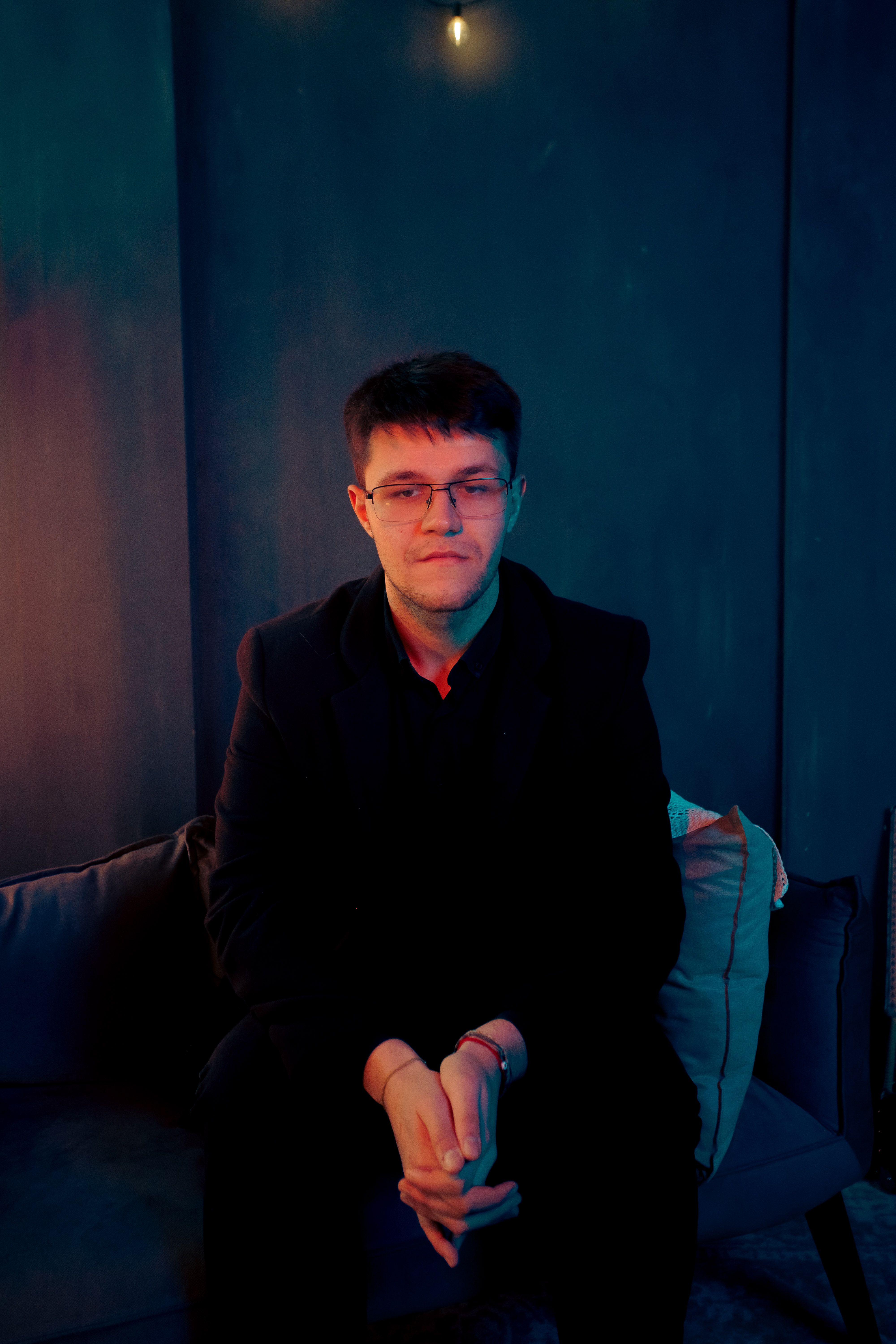 Portrait of a Man Sitting in Dimly Lit Room · Free Stock Photo