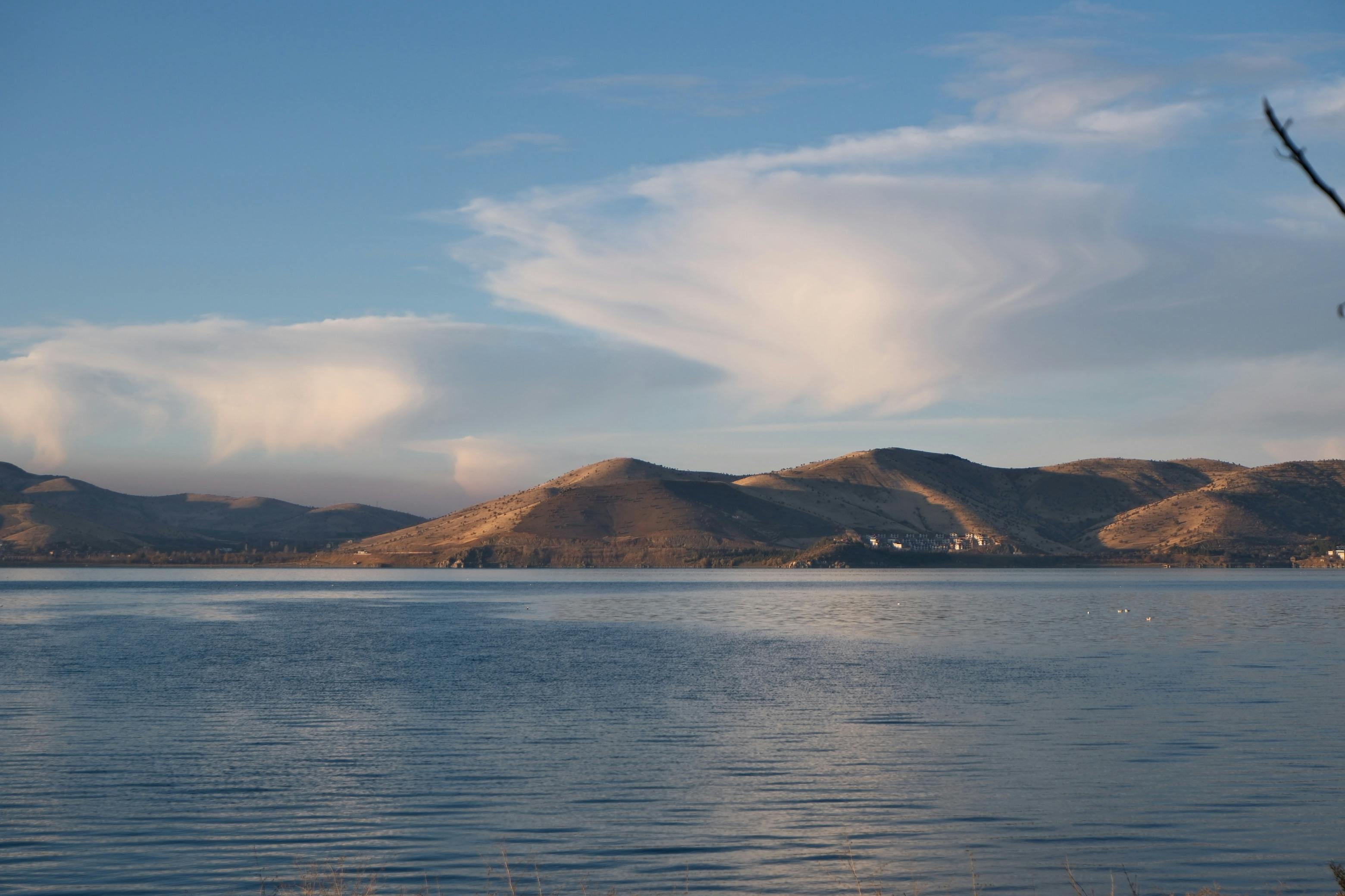 Scenic View of Mountains Across a Serene Lake · Free Stock Photo