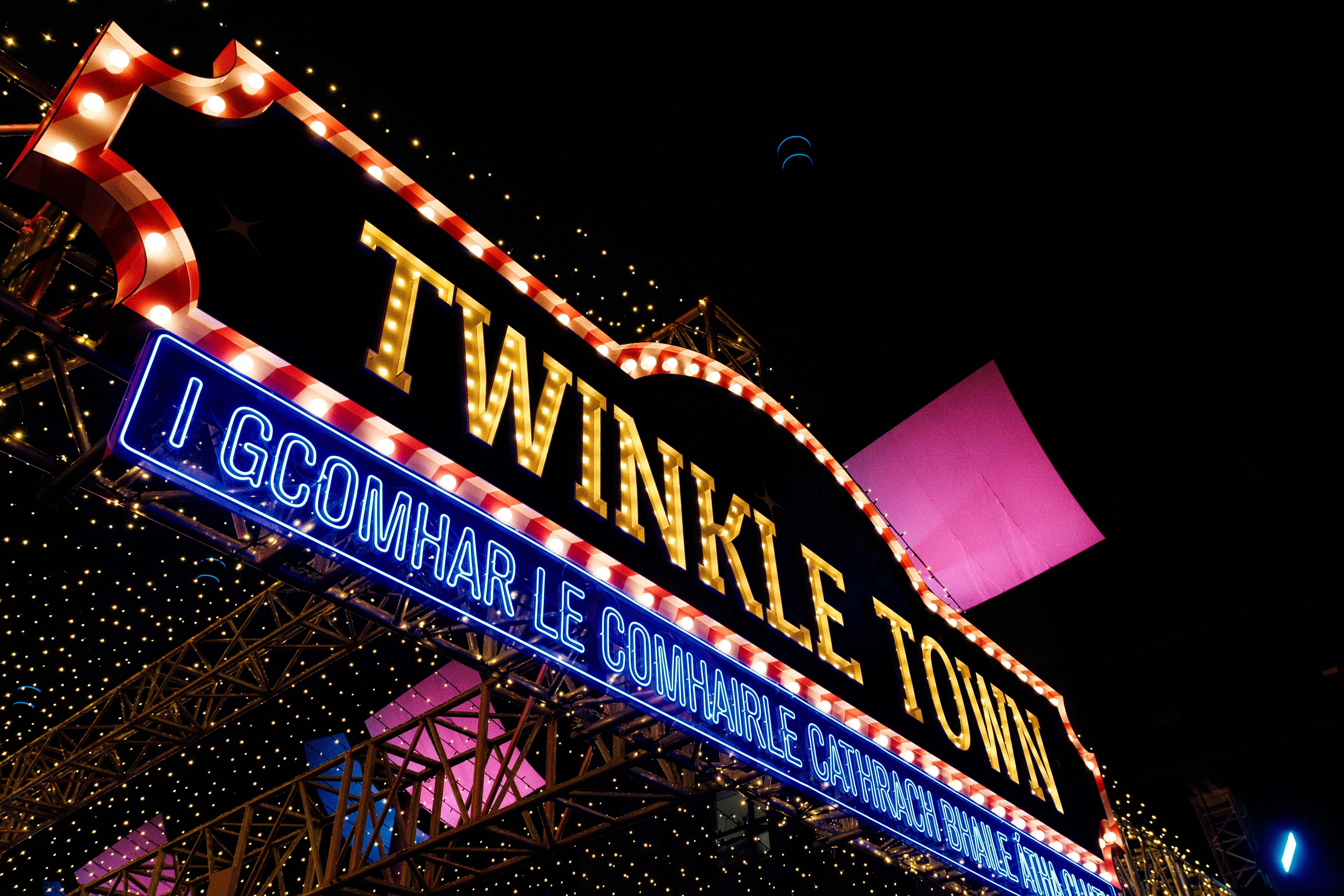 Vibrant Twinkle Town Nighttime Festivity Sign · Free Stock Photo