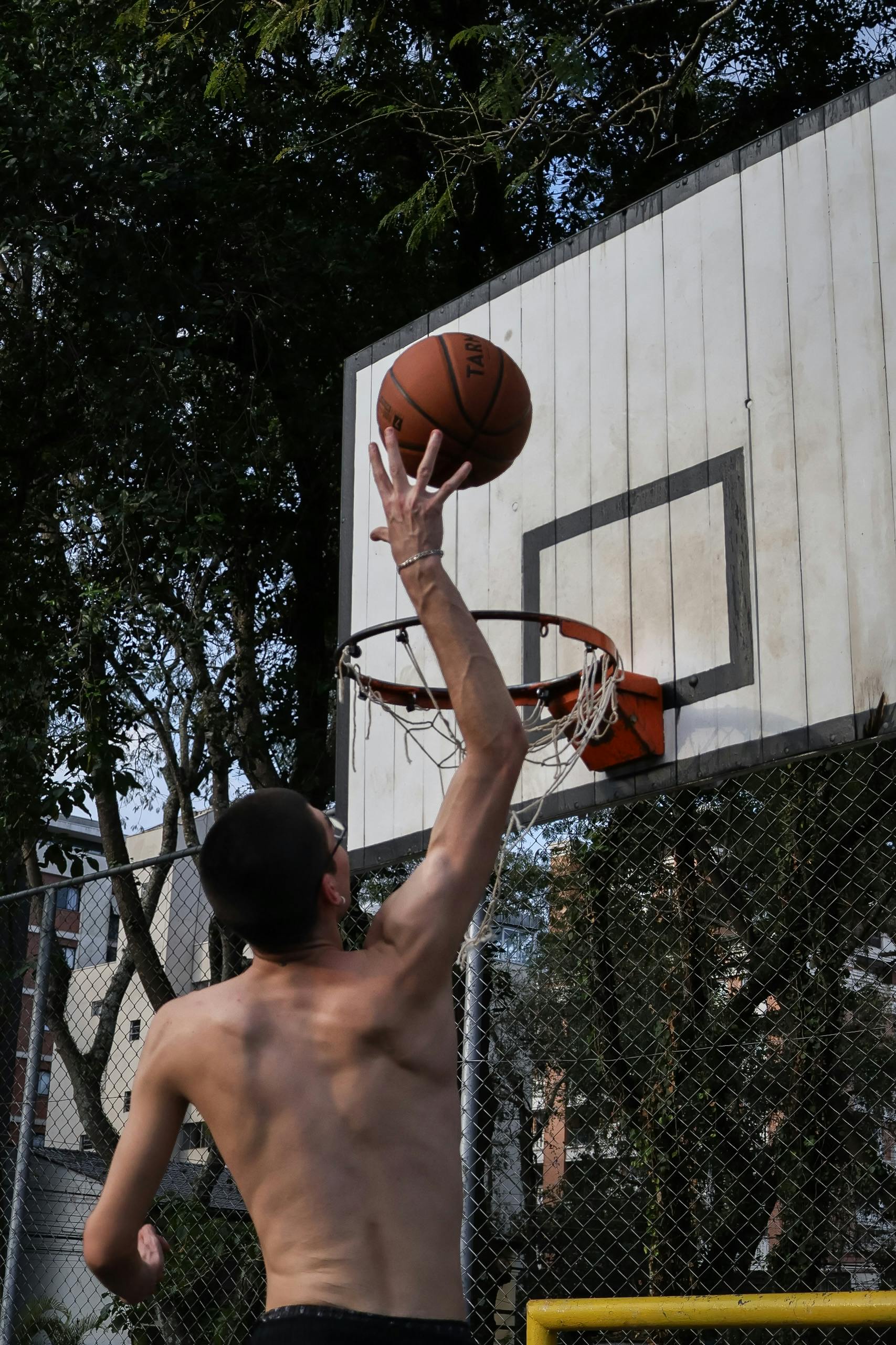 Outdoor Basketball Game: Player Shooting a Hoop · Free Stock Photo