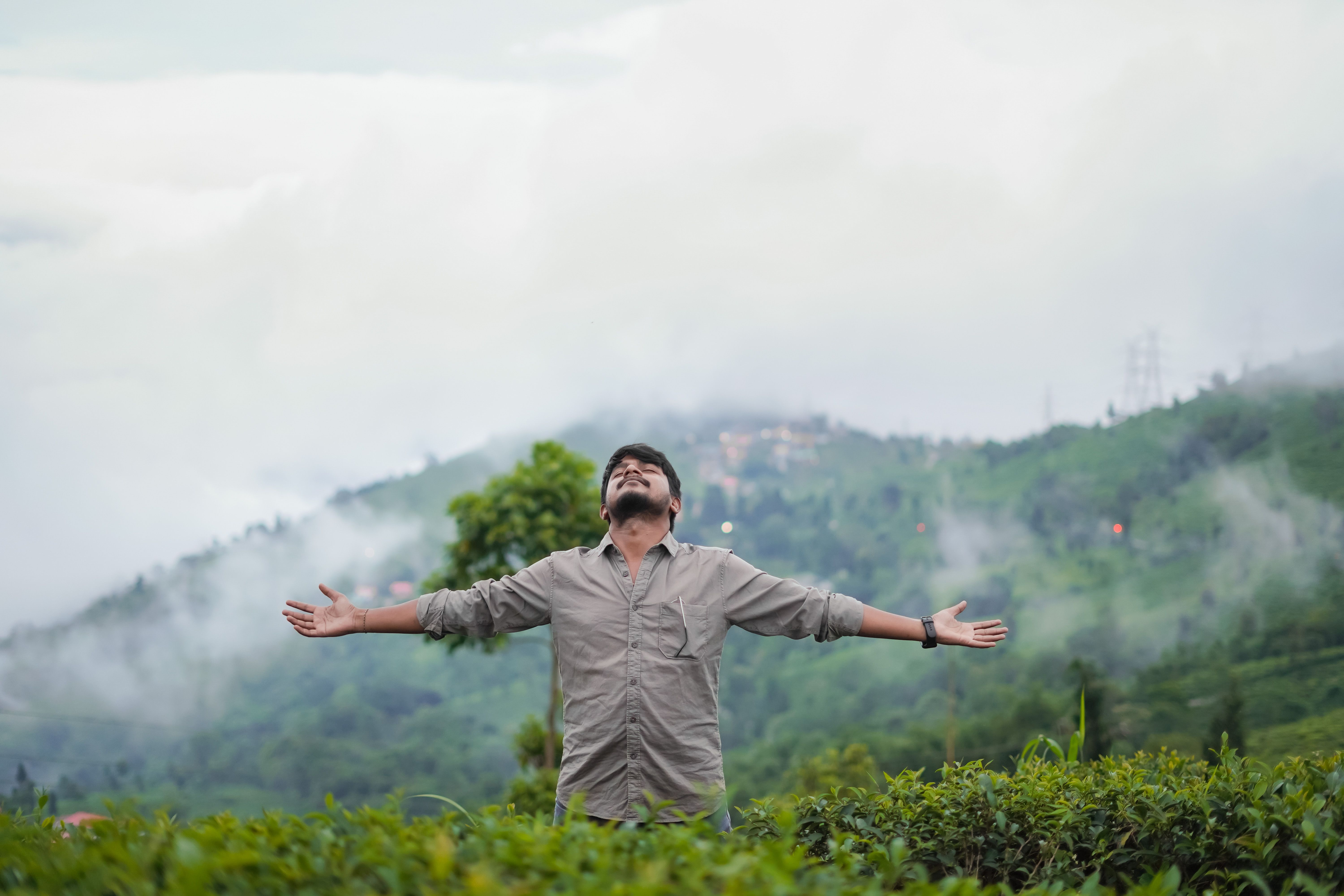 Man Embracing Nature in Misty Mountain Landscape · Free Stock Photo