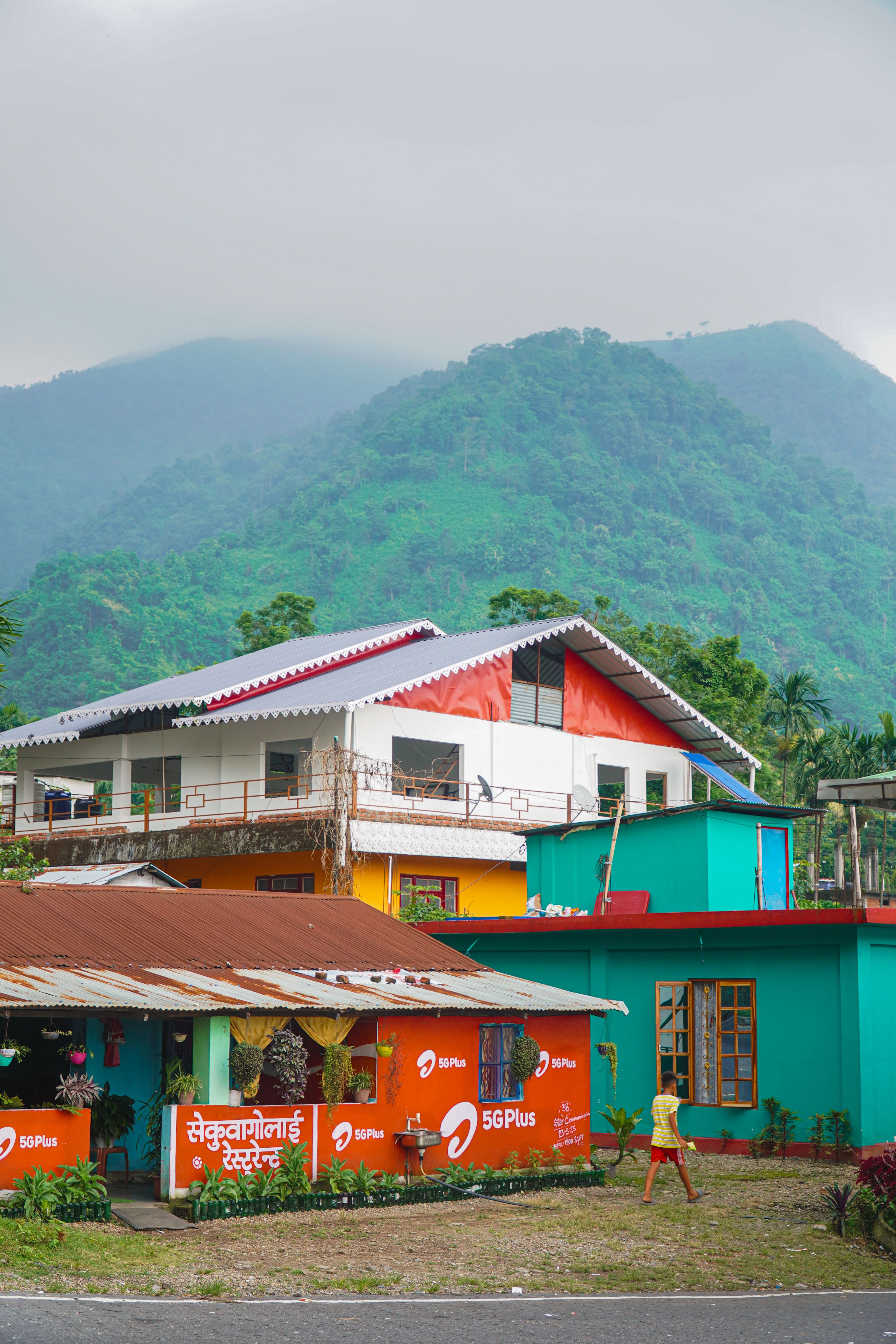 Colorful Rural Village Scene with Mountain Backdrop · Free Stock Photo