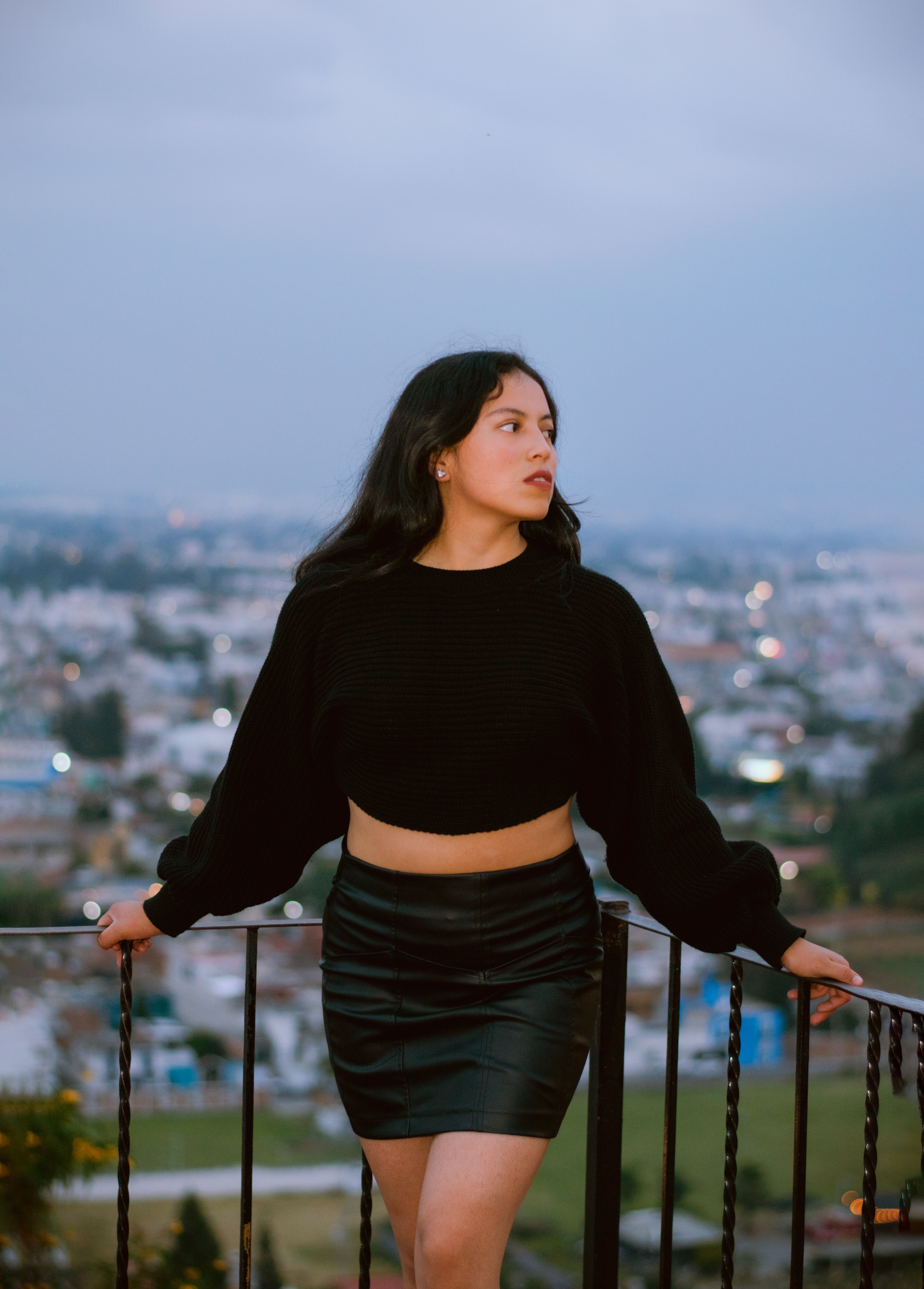 Urban Woman Overlooking Cityscape at Twilight · Free Stock Photo