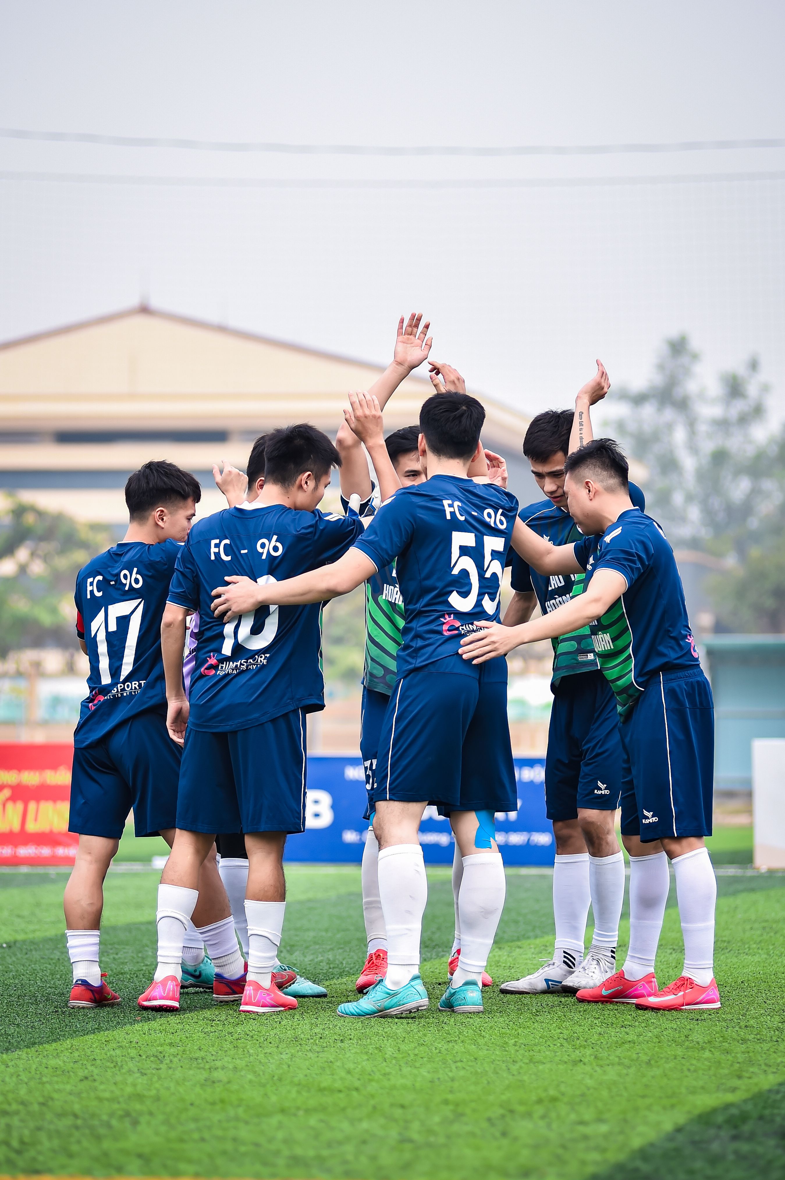 Youth Soccer Team Huddling on Field in Hanoi · Free Stock Photo