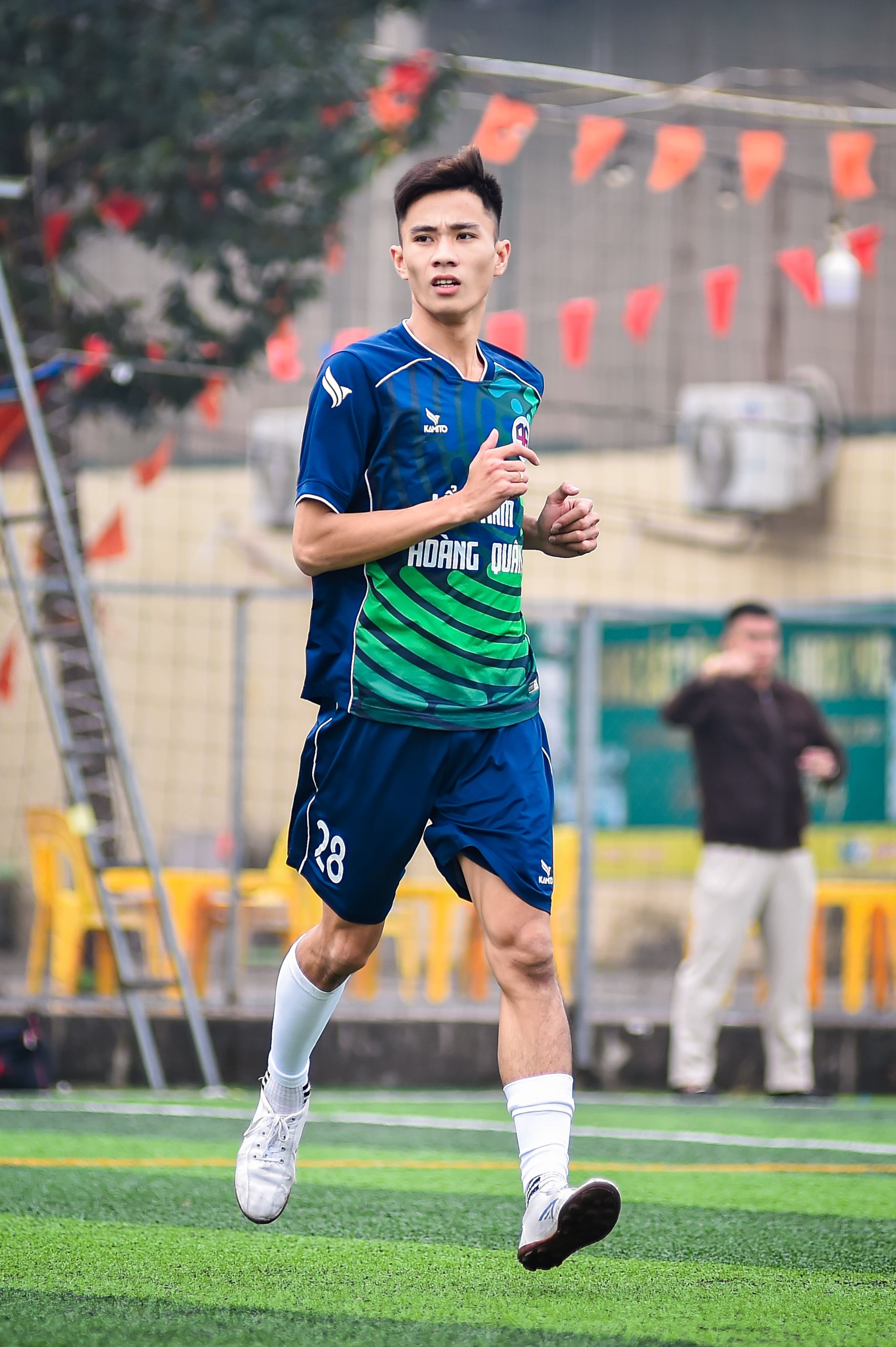 Young Asian Footballer in Action on Hanoi Soccer Field · Free Stock Photo