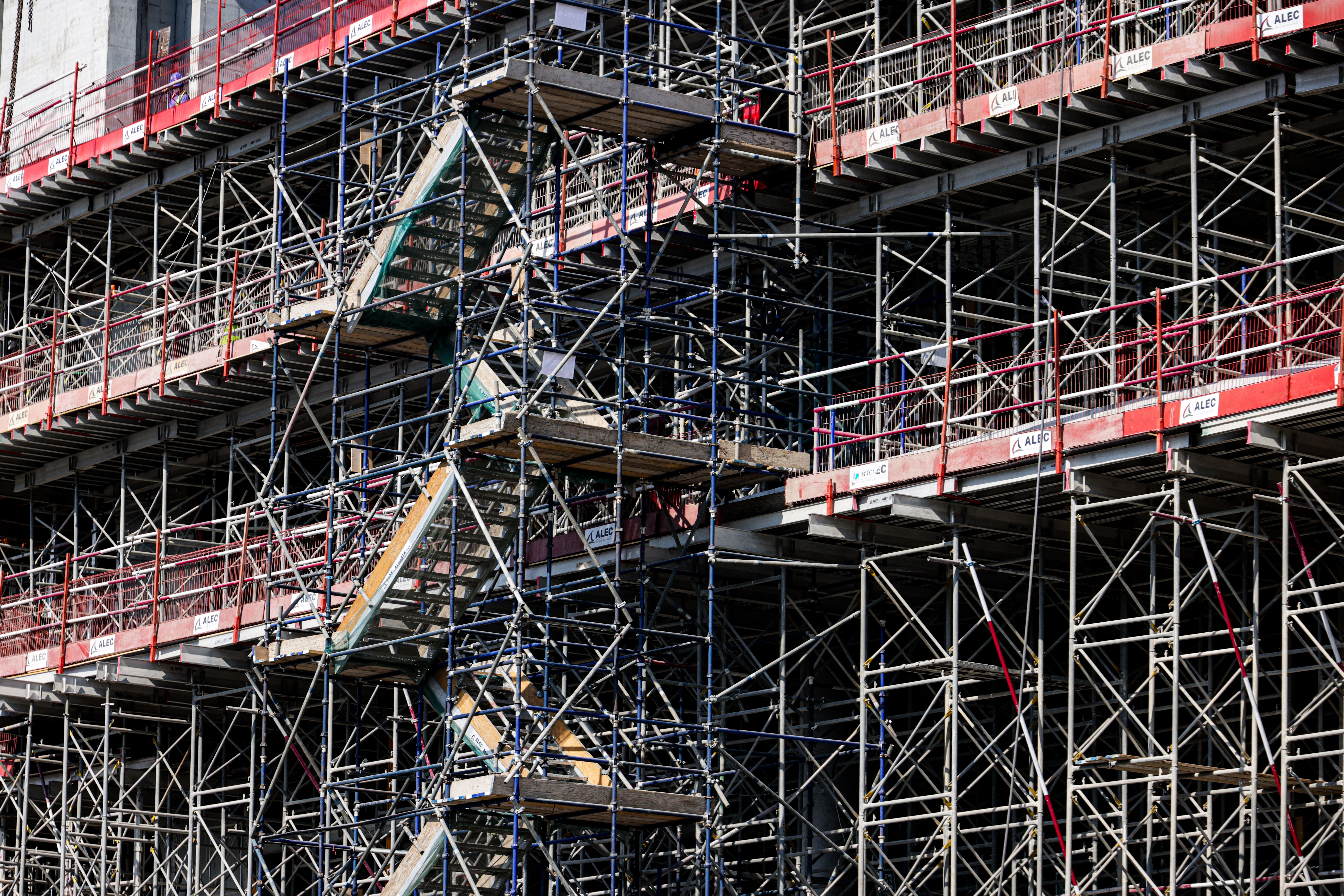 Scaffolding Surrounding Modern Building Structure · Free Stock Photo
