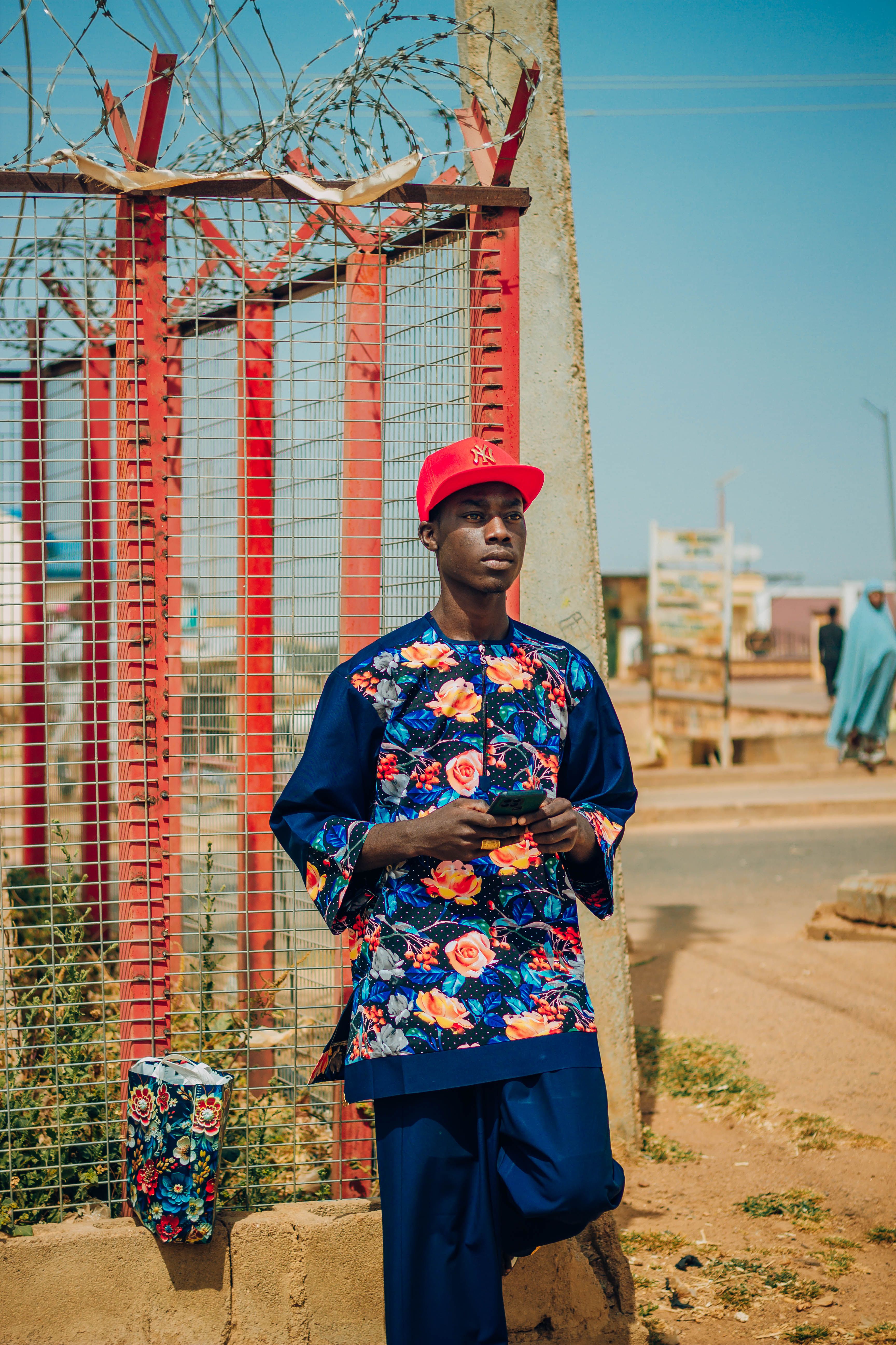 Young Man in Vibrant Floral Attire Outdoors · Free Stock Photo