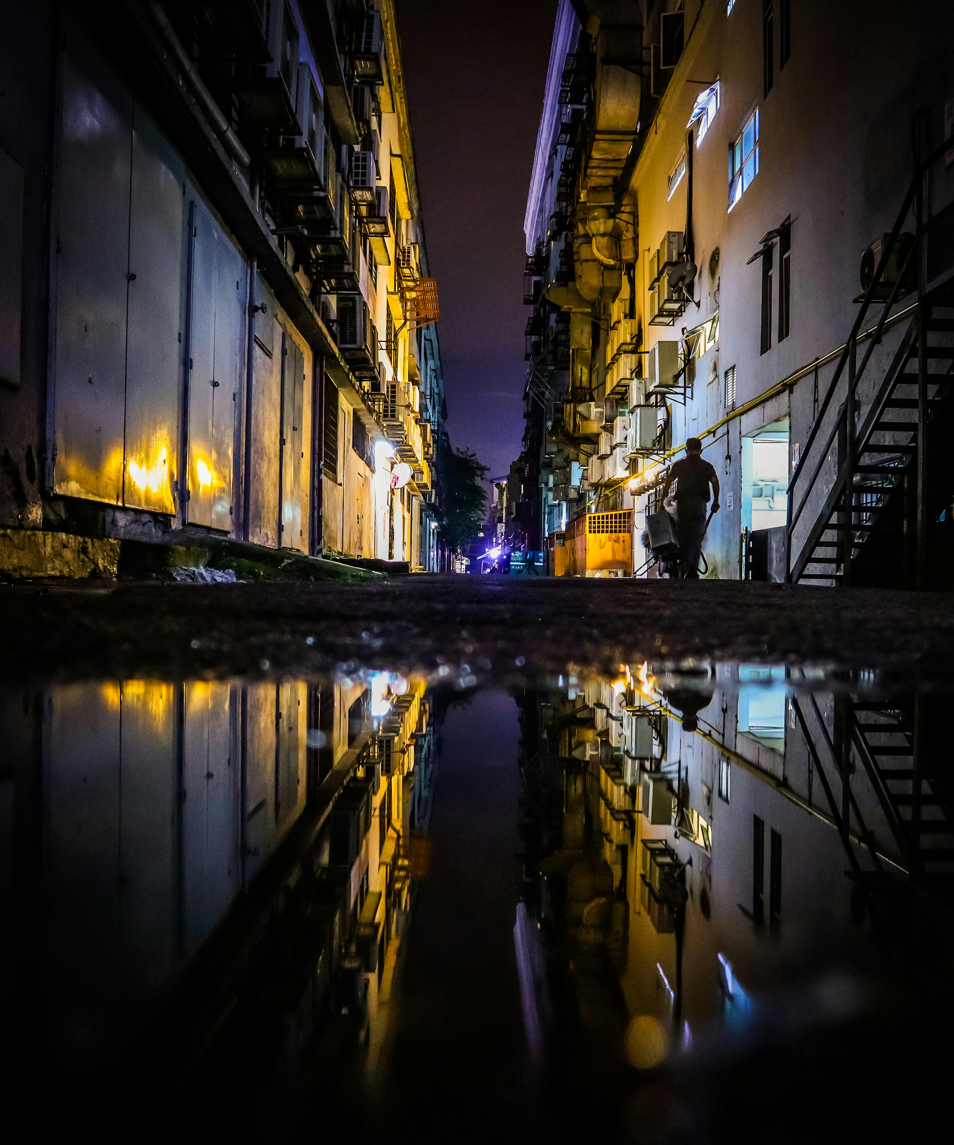 Dramatic Nighttime Alley Reflection Scene · Free Stock Photo