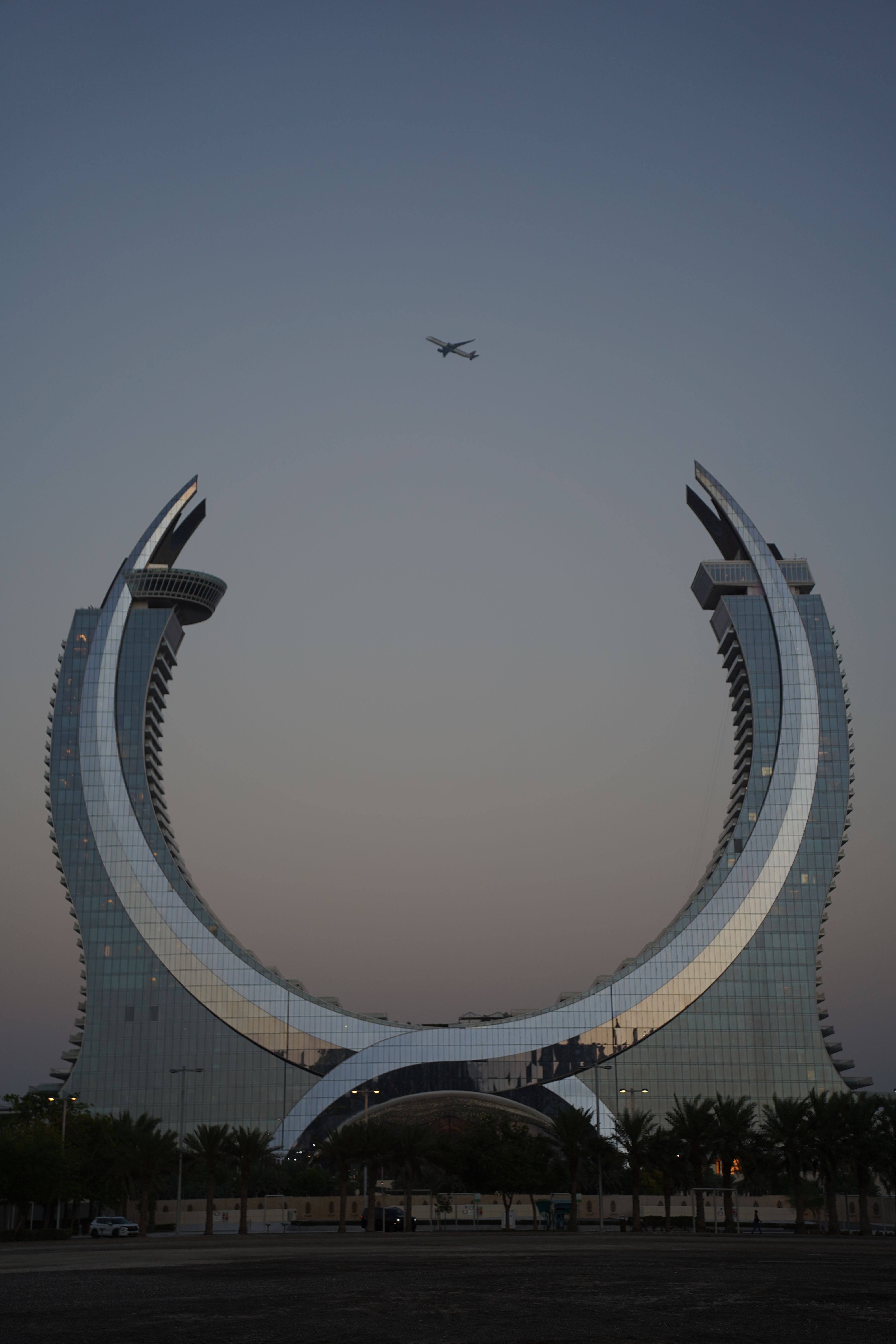 Iconic Crescent Tower Building in Doha at Dusk · Free Stock Photo