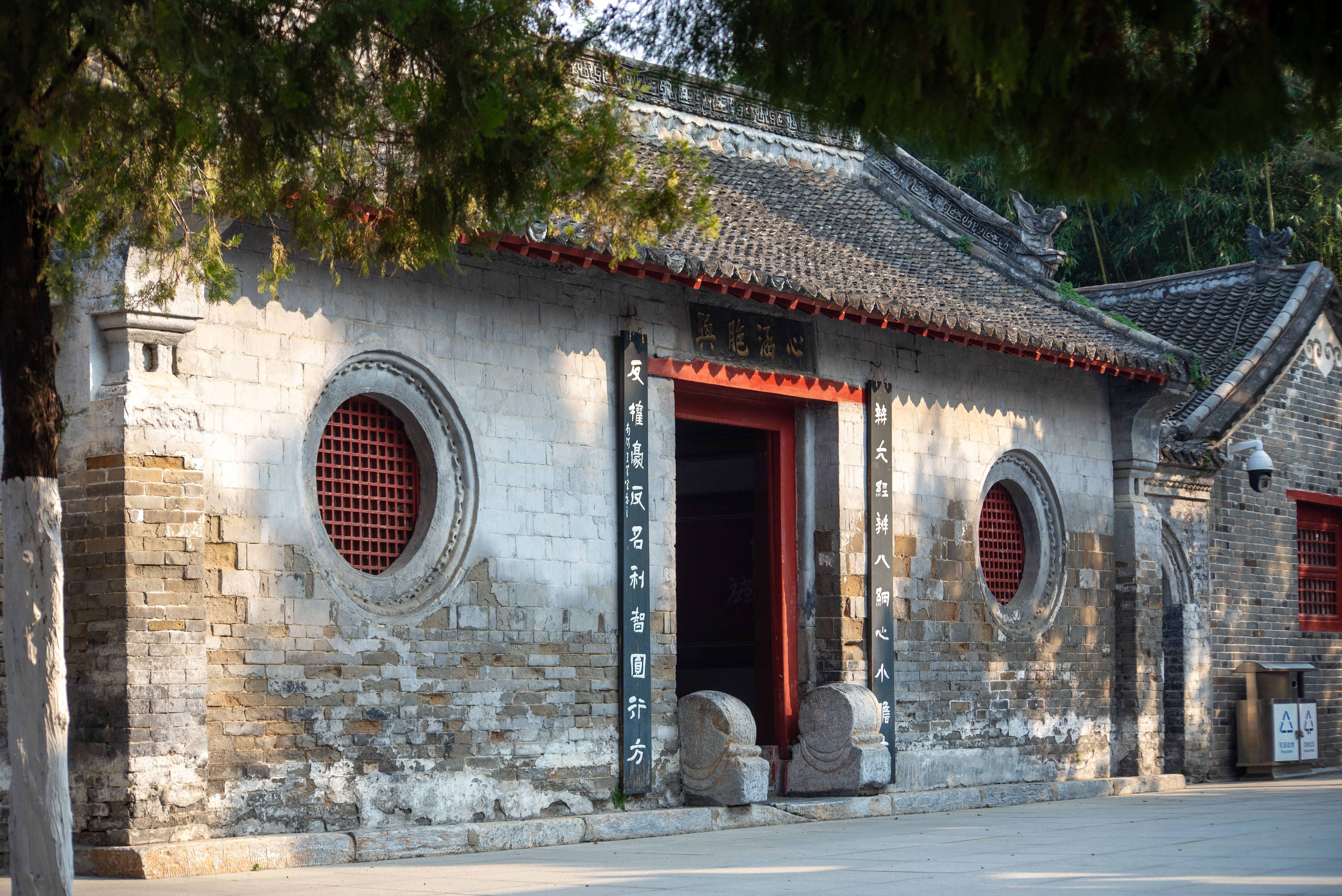 Historic Chinese Temple Entrance with Circular Windows · Free Stock Photo
