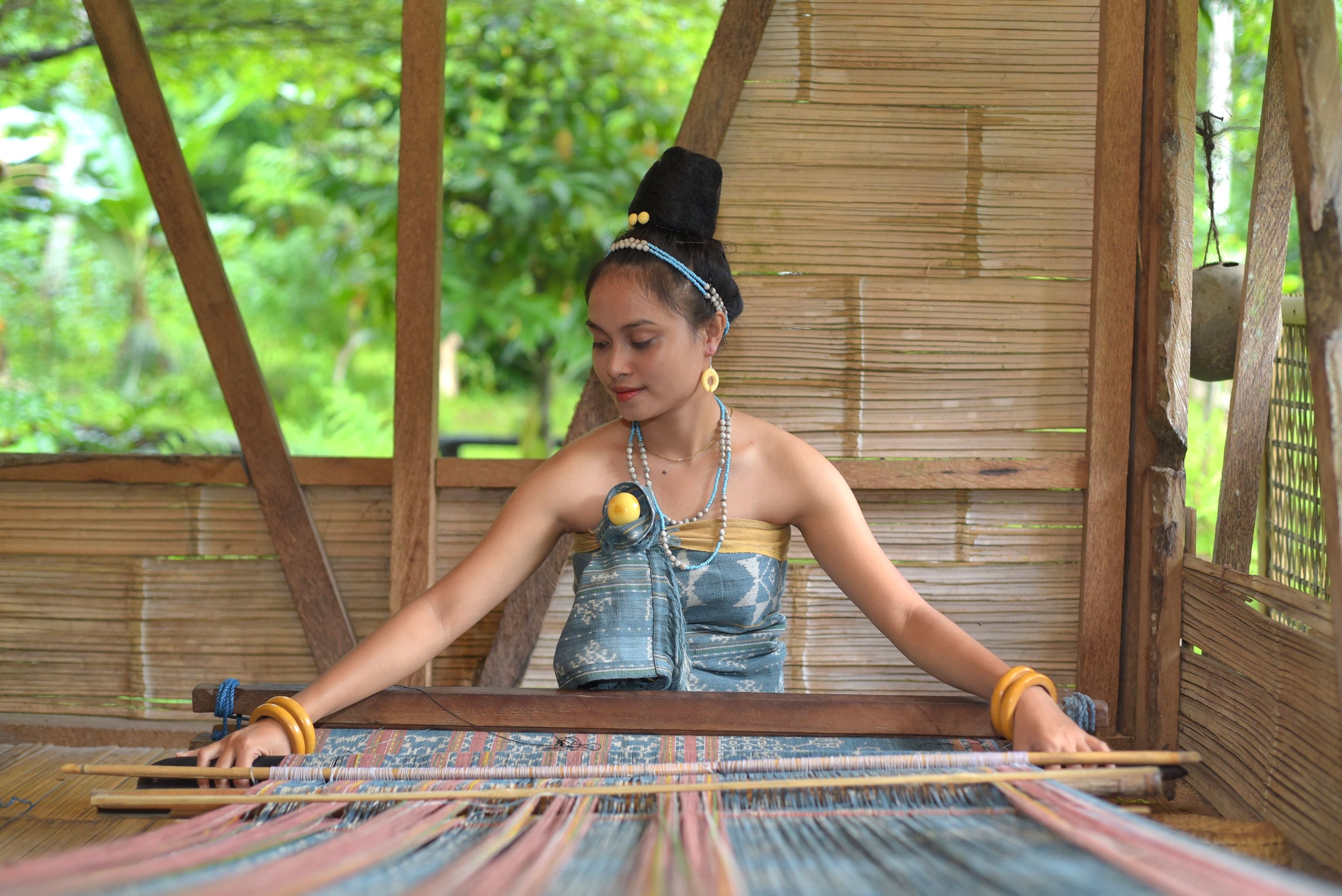 Traditional Weaver in Cultural Dress Indoors · Free Stock Photo