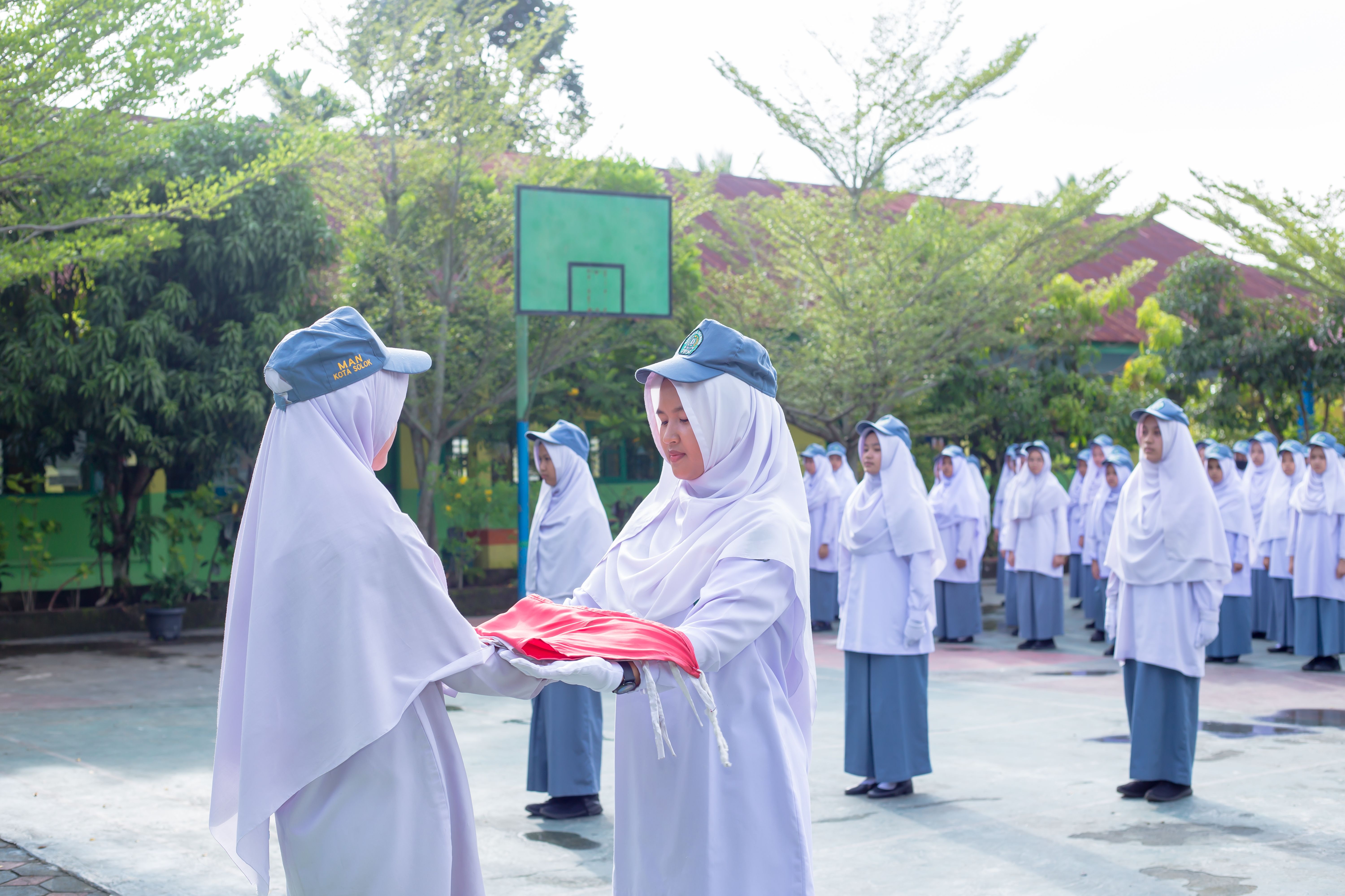 Ceremonial Flag Exchange in School Yard · Free Stock Photo
