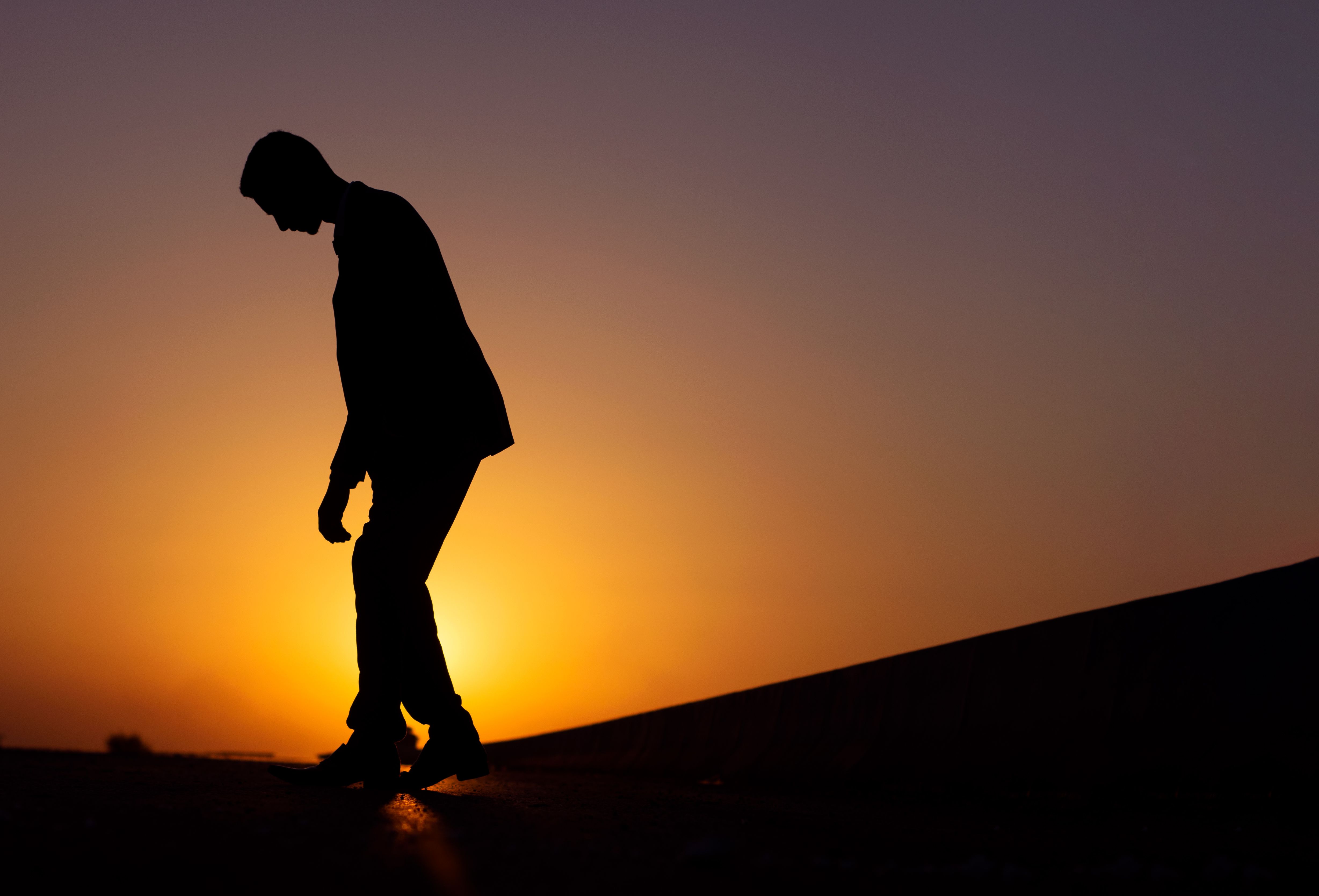 Silhouette of Person Walking at Sunset · Free Stock Photo