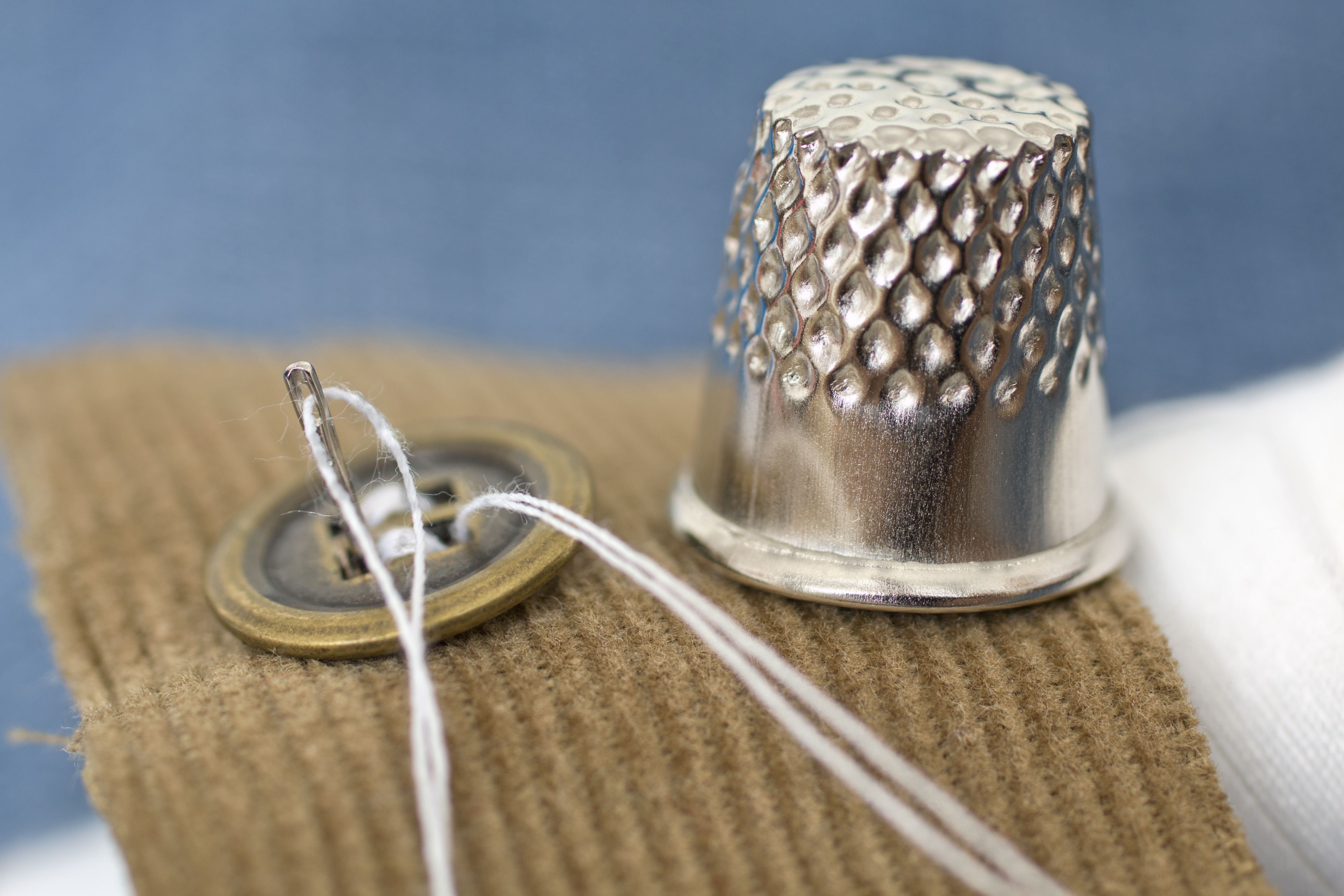 Close-Up of Sewing Button and Thimble · Free Stock Photo