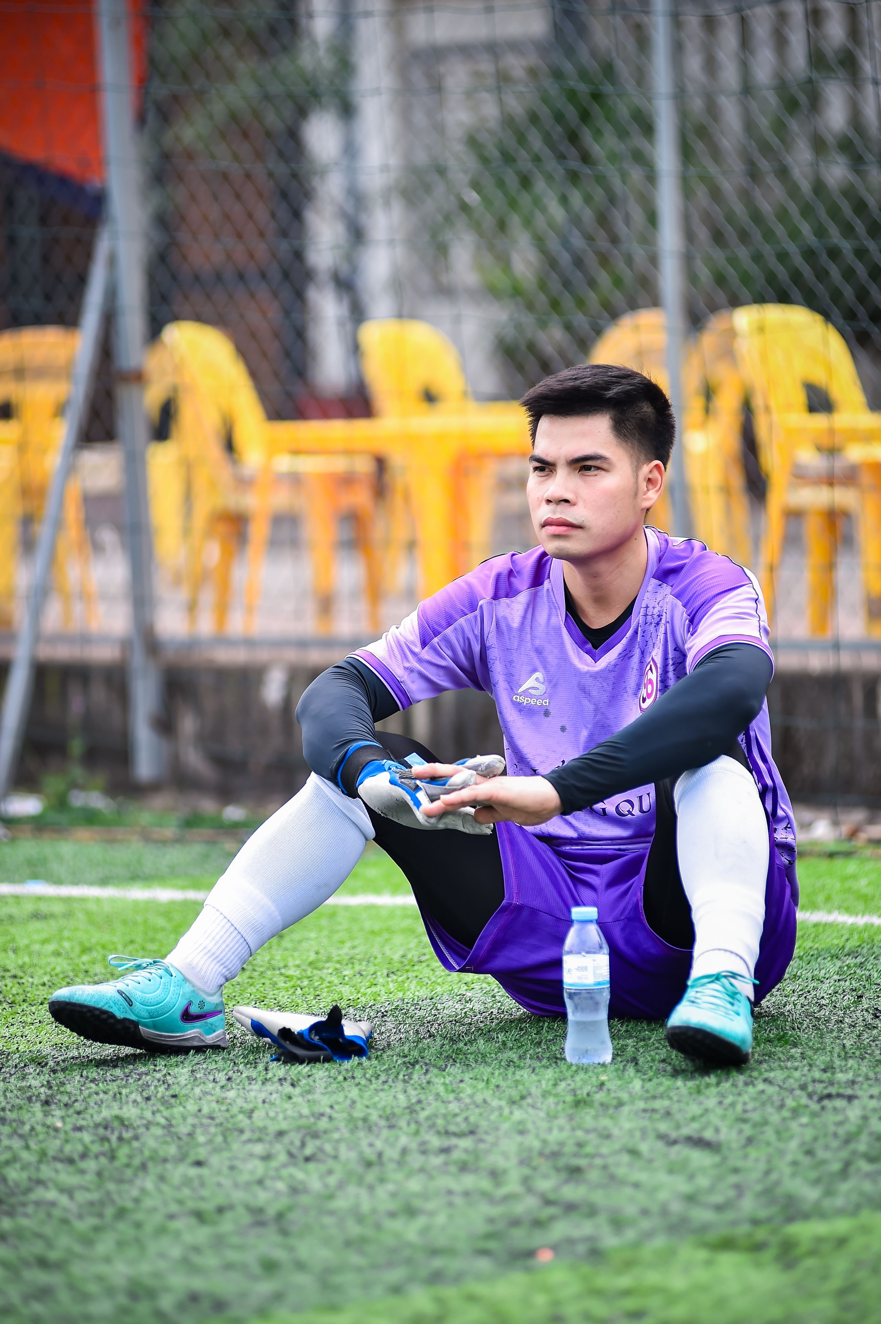 Young Soccer Player Resting on Field in Hanoi · Free Stock Photo
