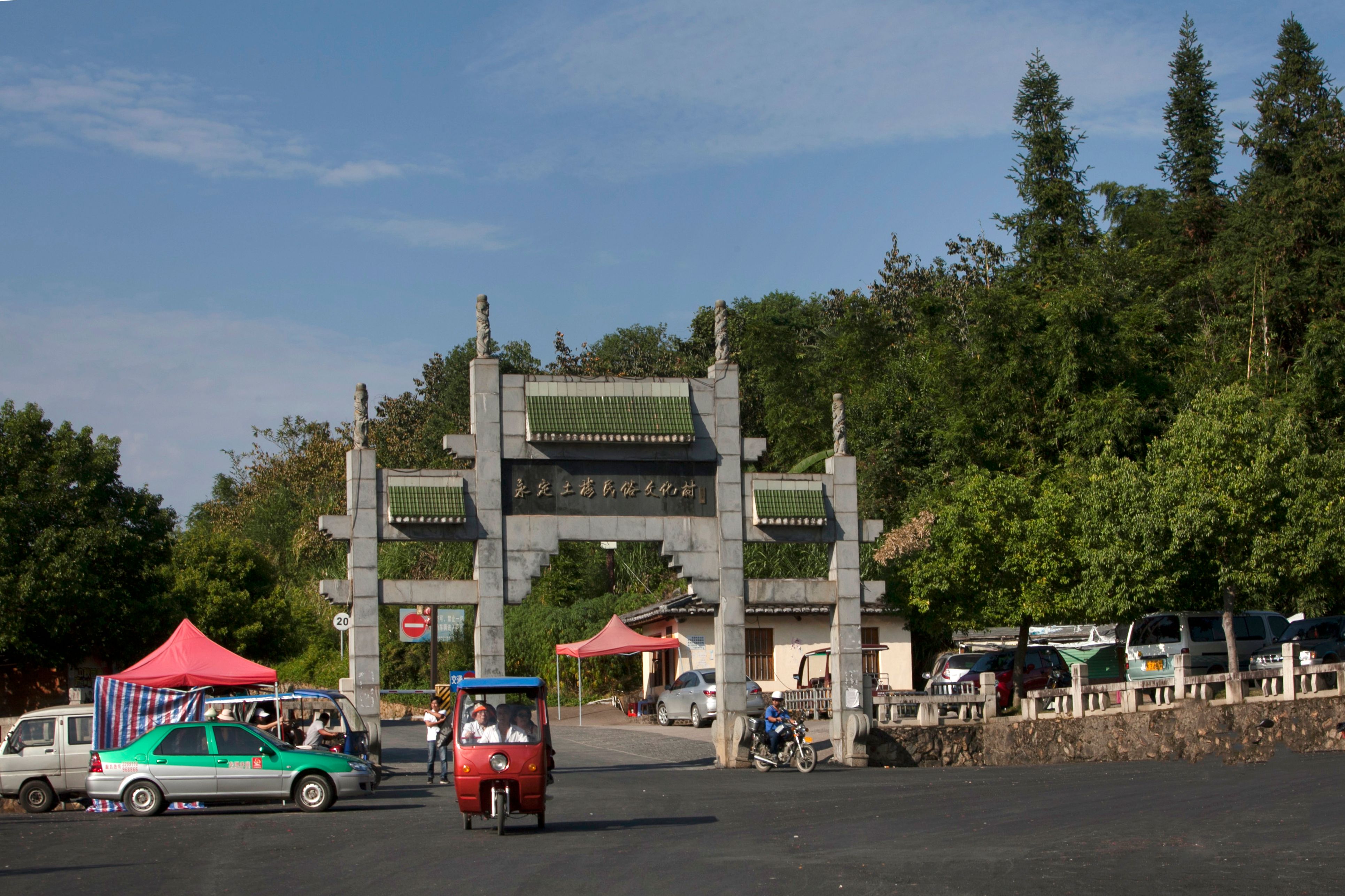 Traditional Chinese Stone Gateway with Vehicles · Free Stock Photo