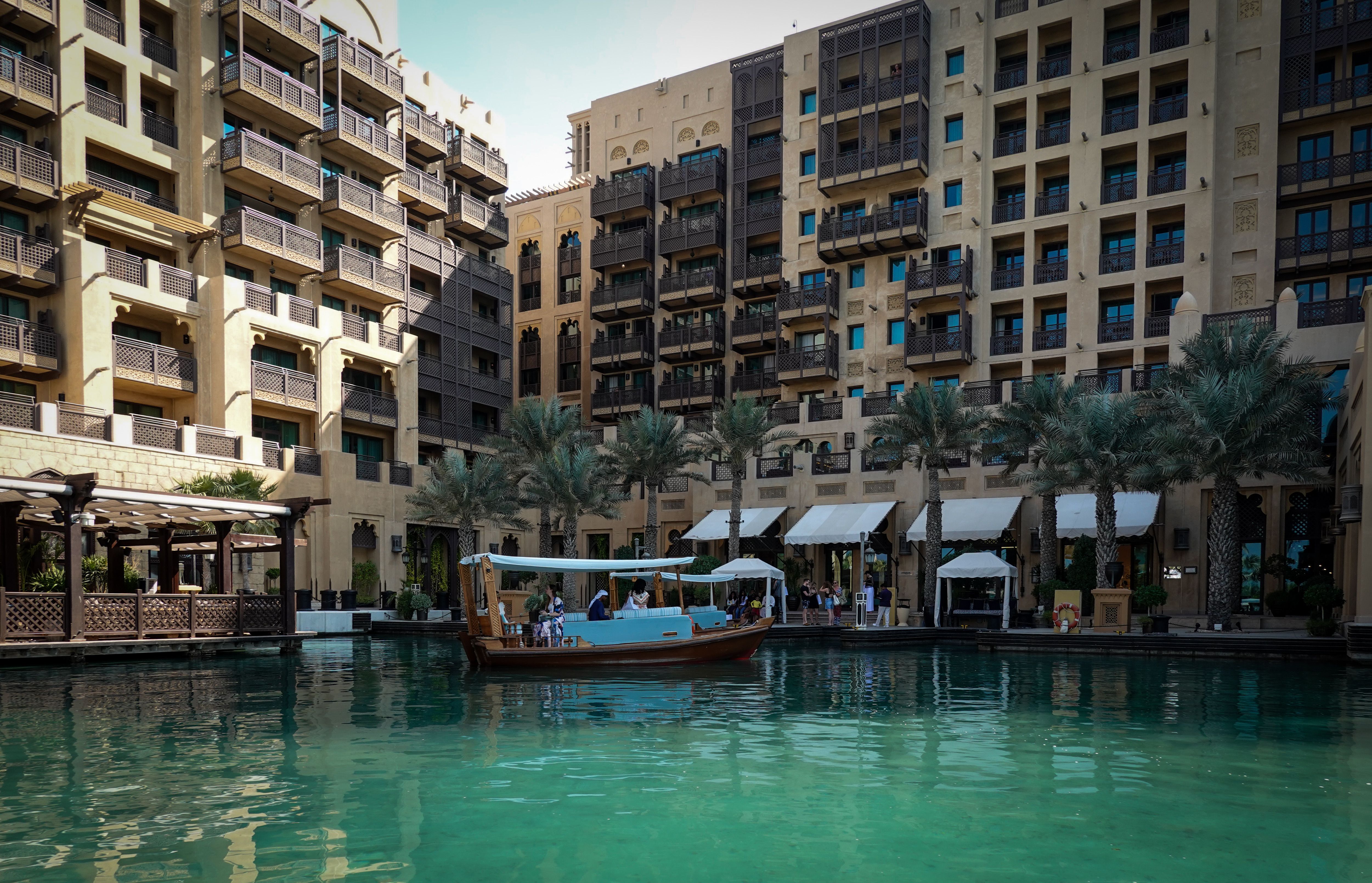 Luxury Resort with Traditional Boat and Palm Trees · Free Stock Photo